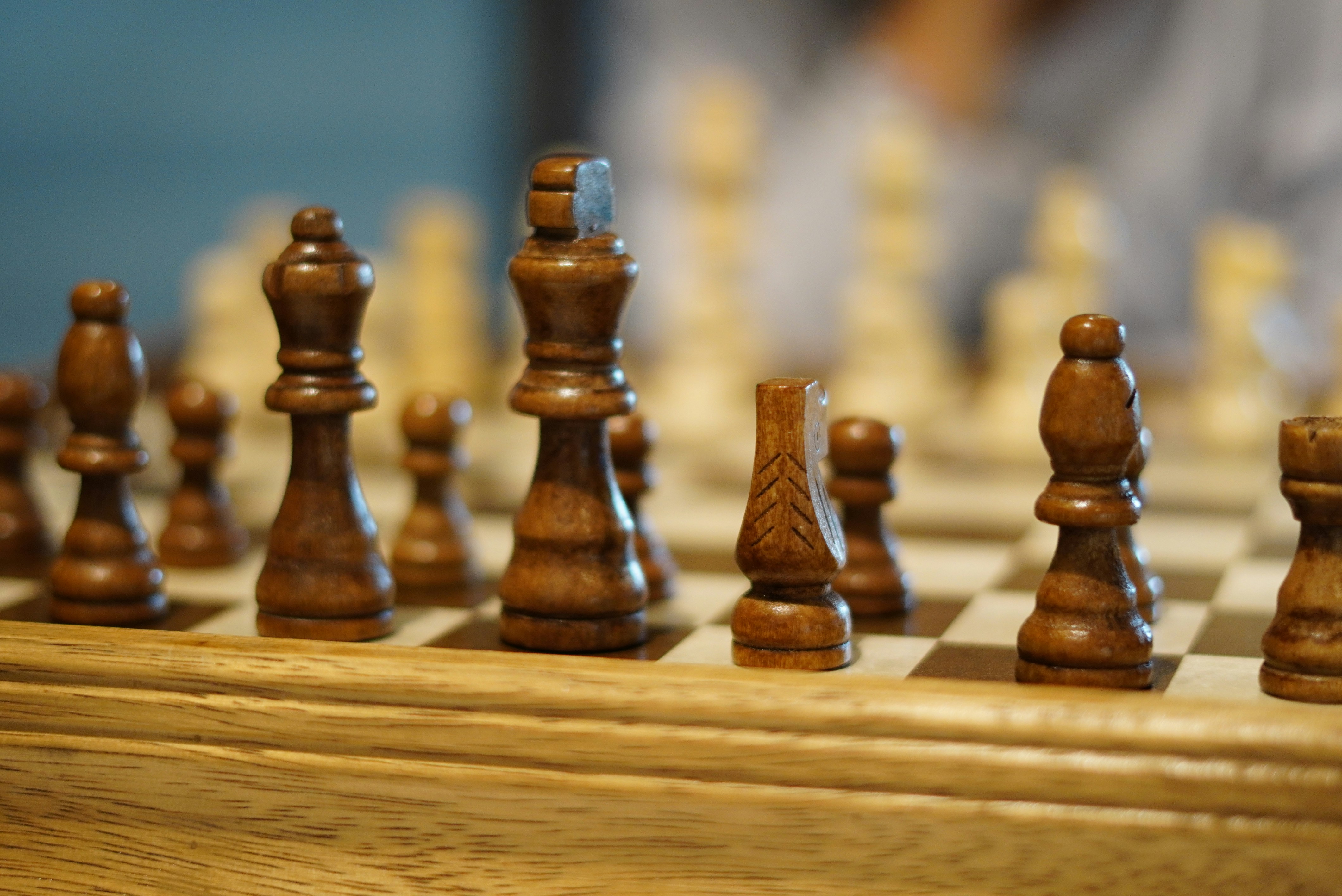 Pawn in Focus: A Chessboard Portrait of Wooden Characters