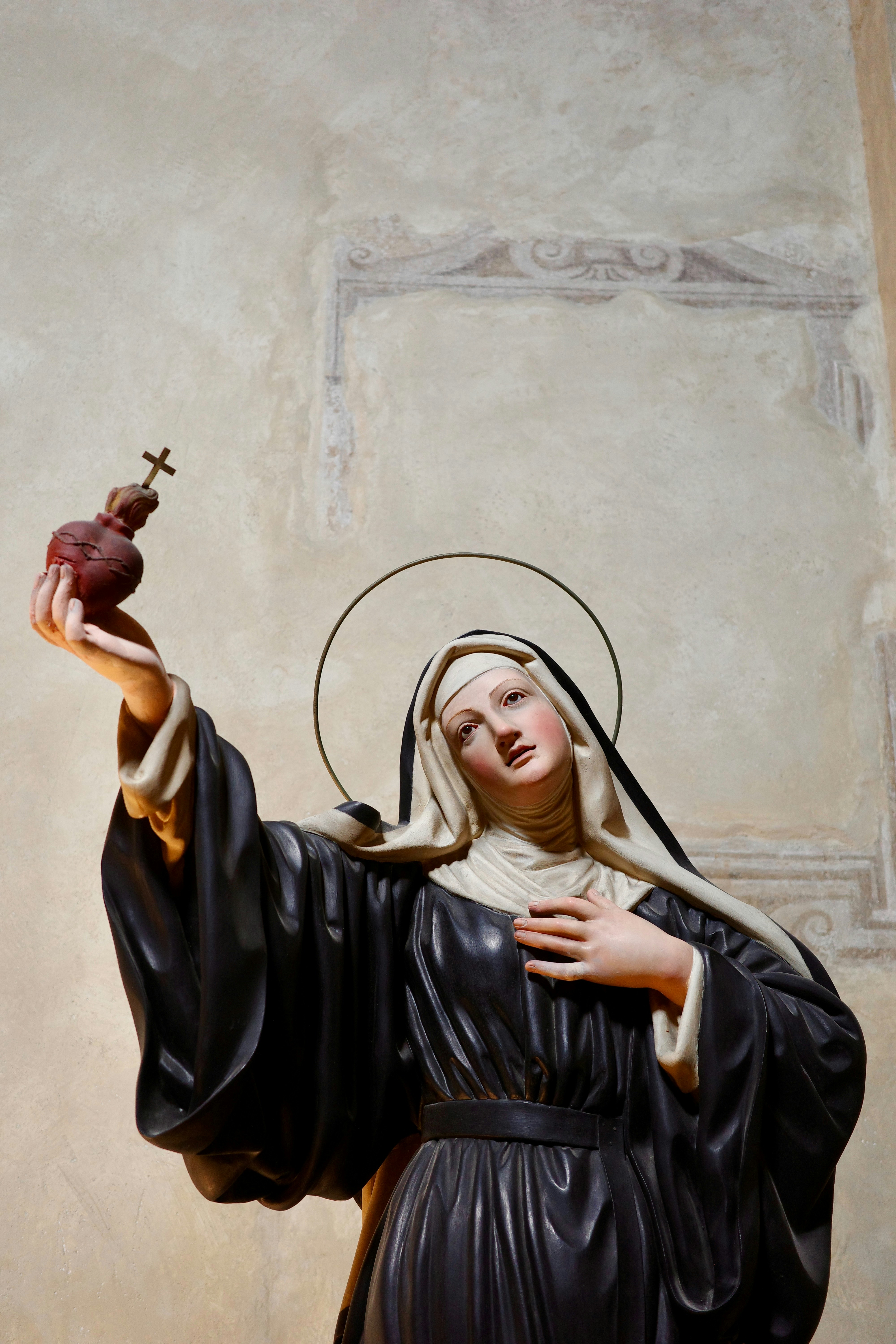Raised Hand, Sacred Gaze: A Statue Reaching Toward the Light