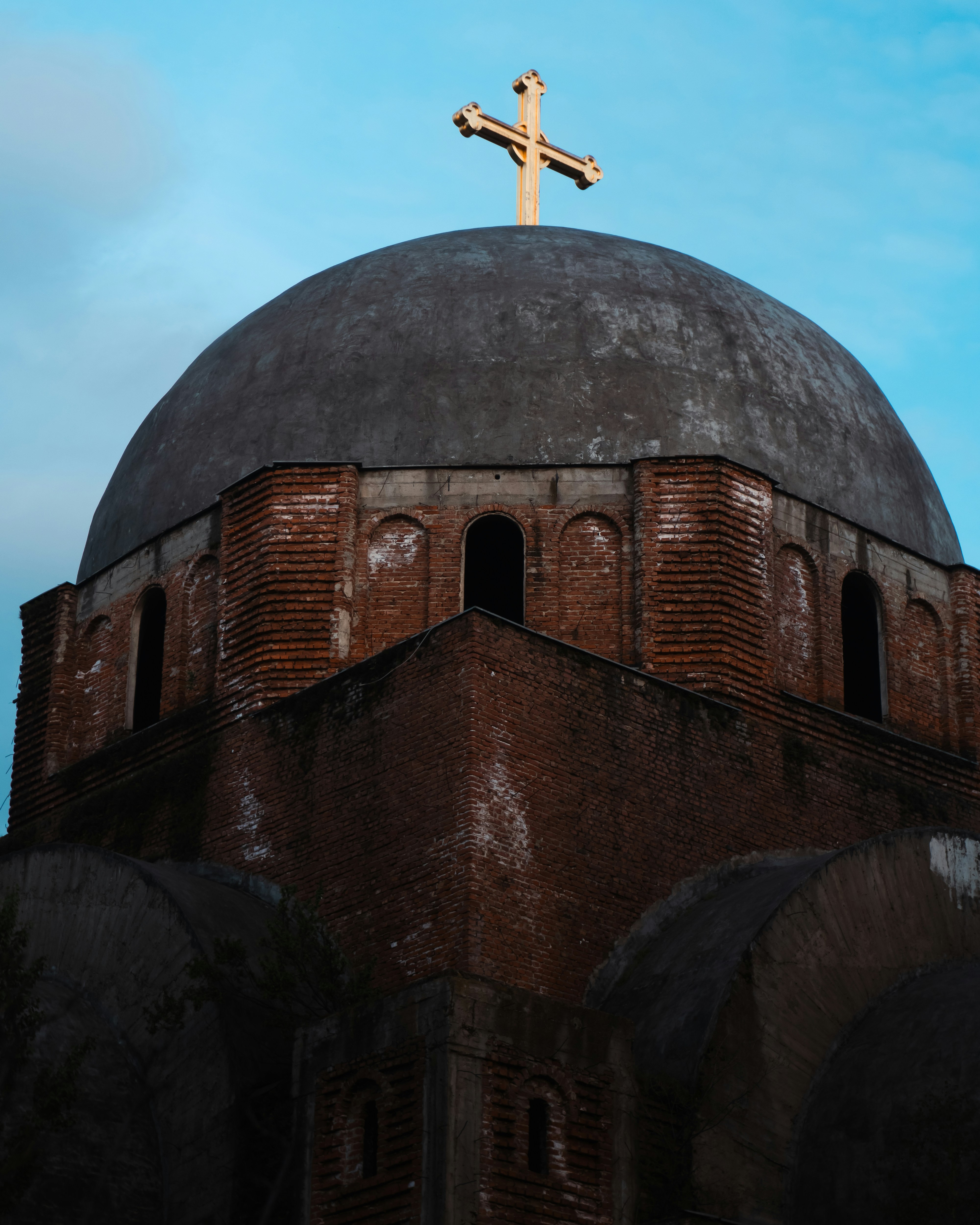 Crossing the Dome: A Weathered Chapel Crowned by a Silent Cross