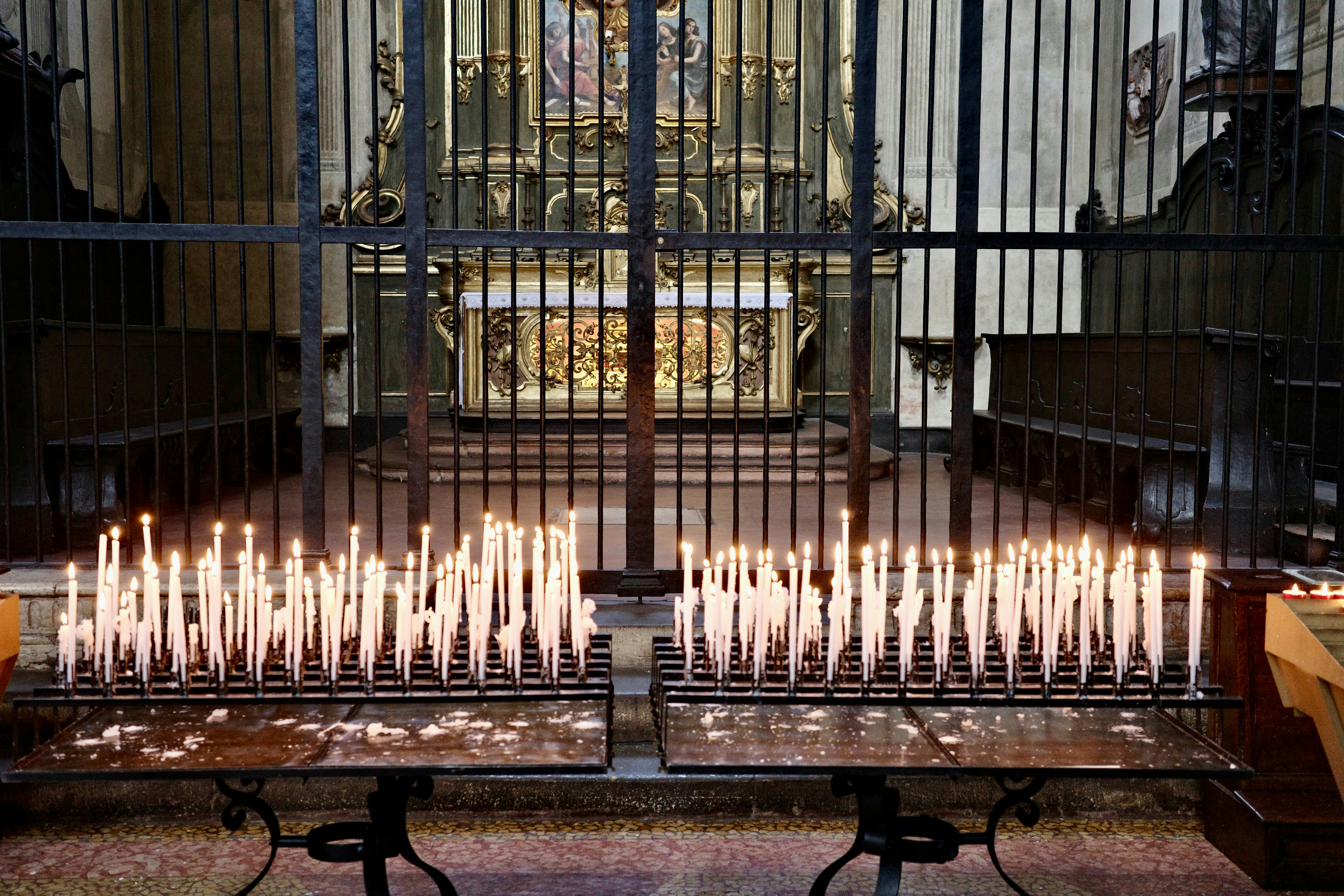 Rows of Candle Light in a Sacred Hall