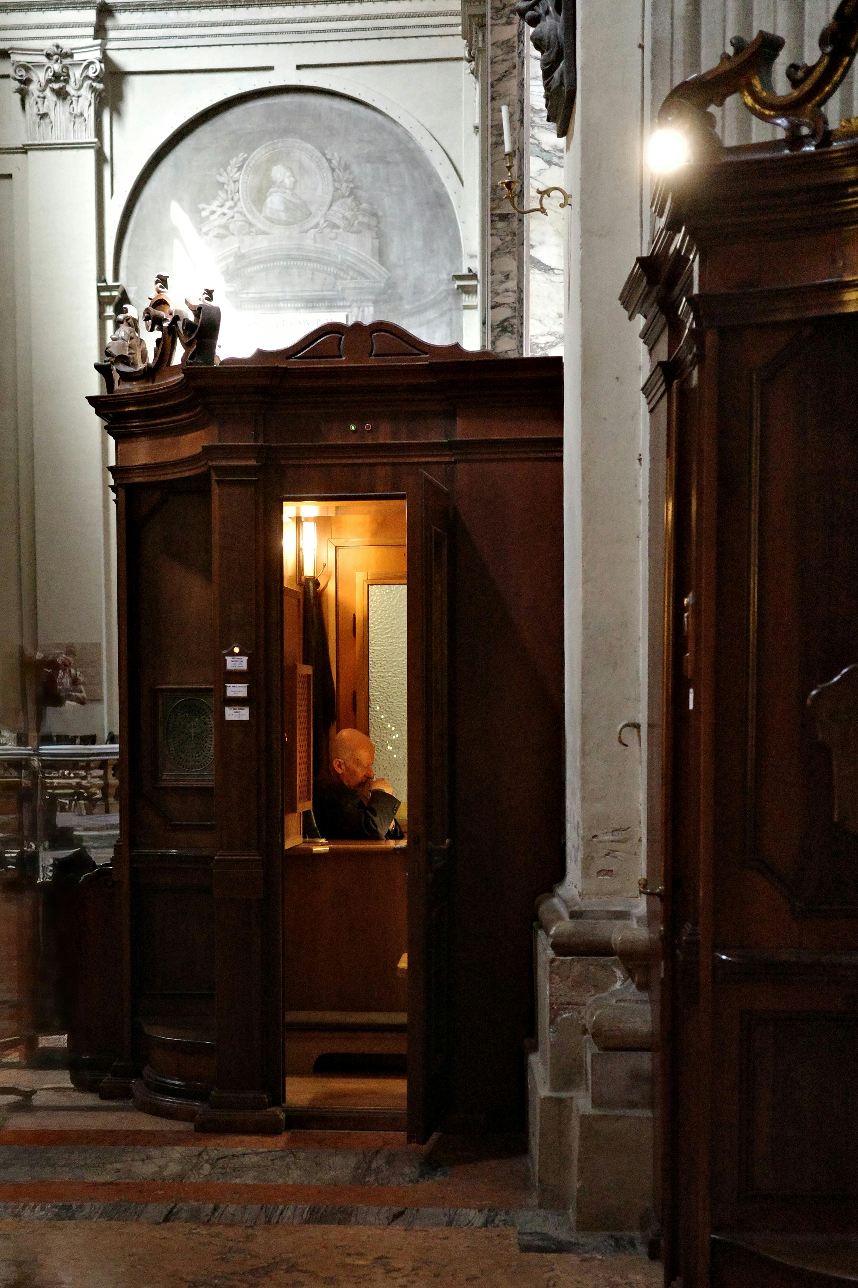 Illuminated Custodian: A Conductor in a Quiet Cathedral Nook