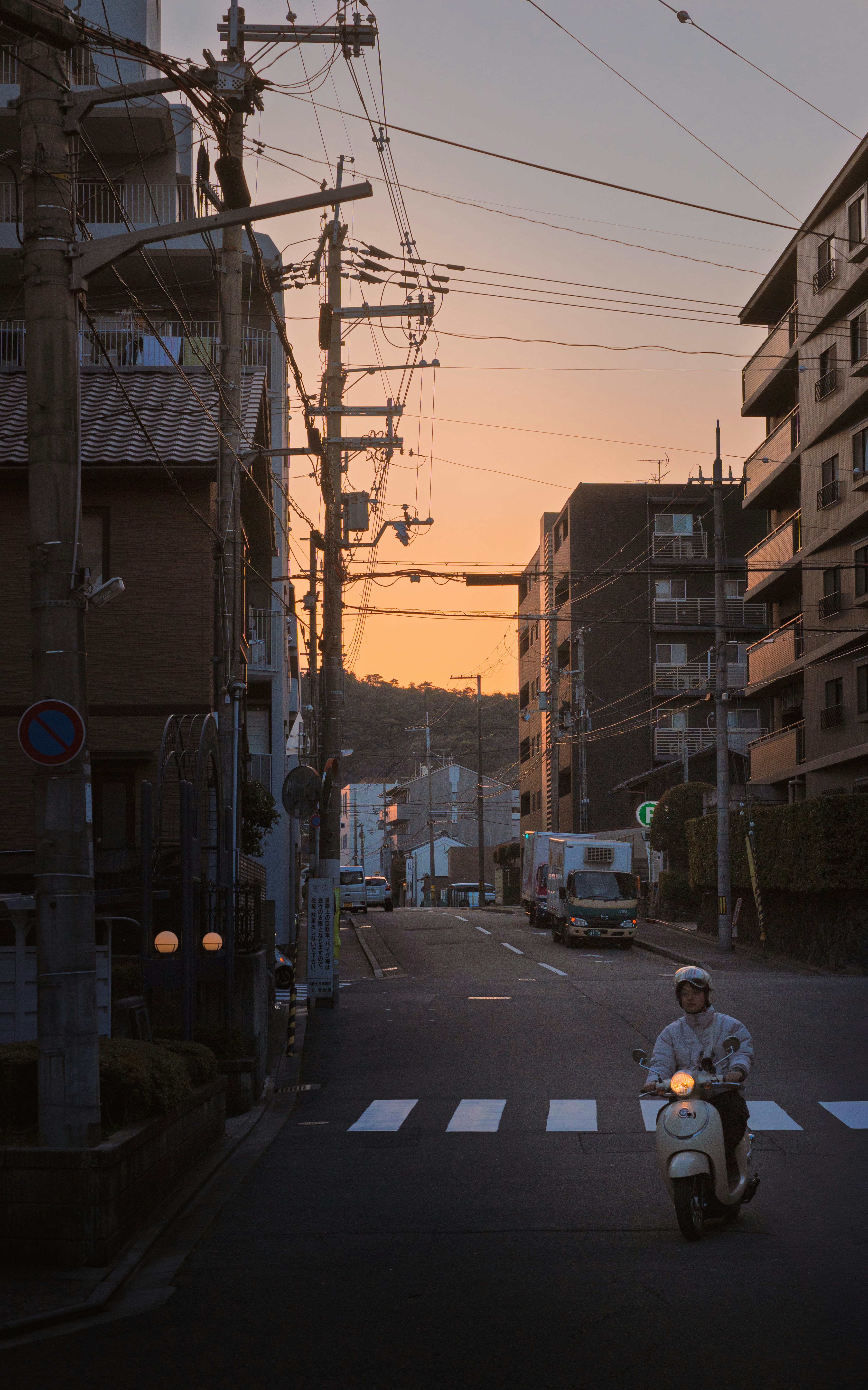 Evening Ascent: A Vespa Gates the Sunset Street