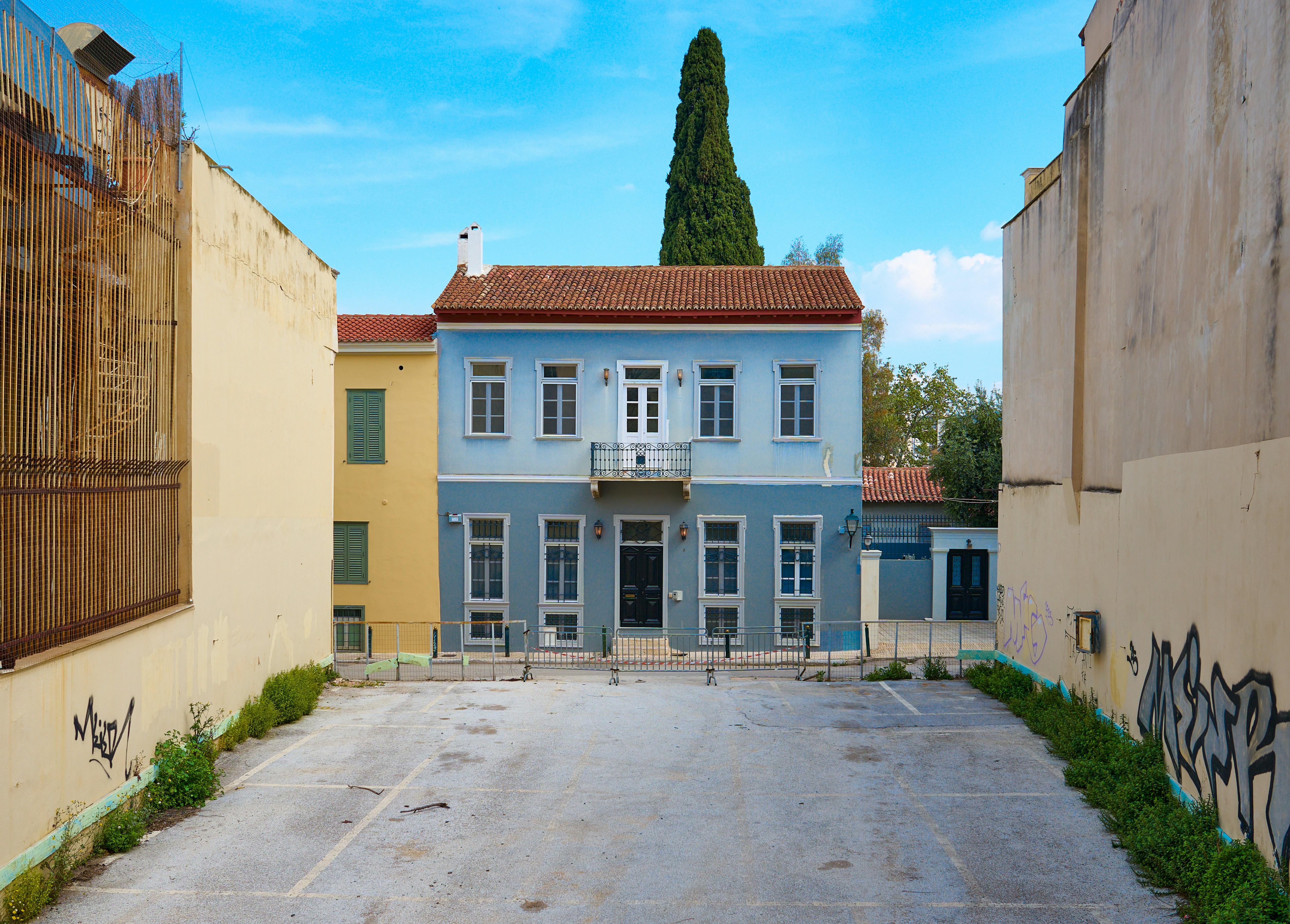 Pastel Facade Quartet: A Quiet Courtyard with Central Blue House