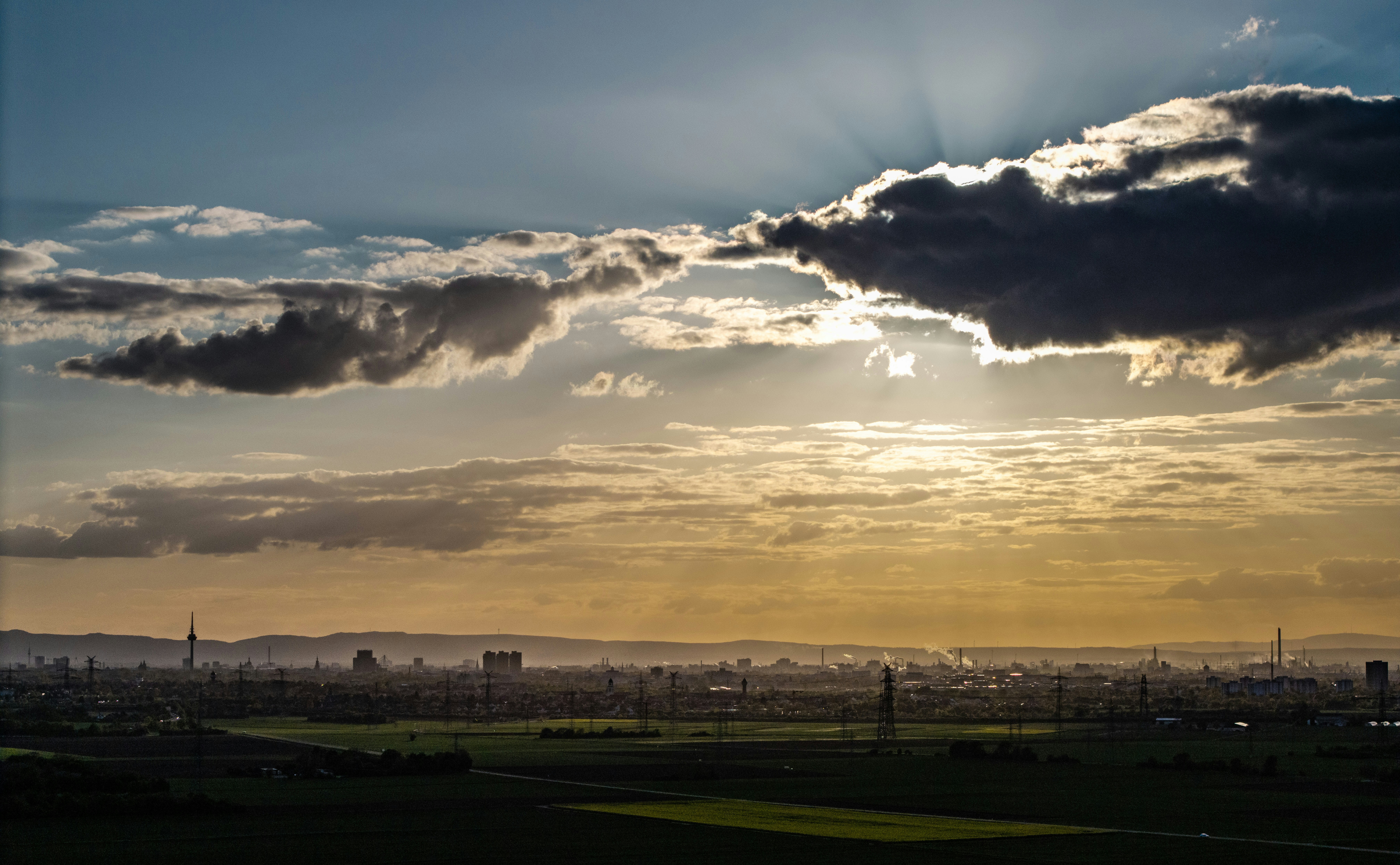 Dusk Over the Plains: Sunlit Horizon Beyond a Quiet Field