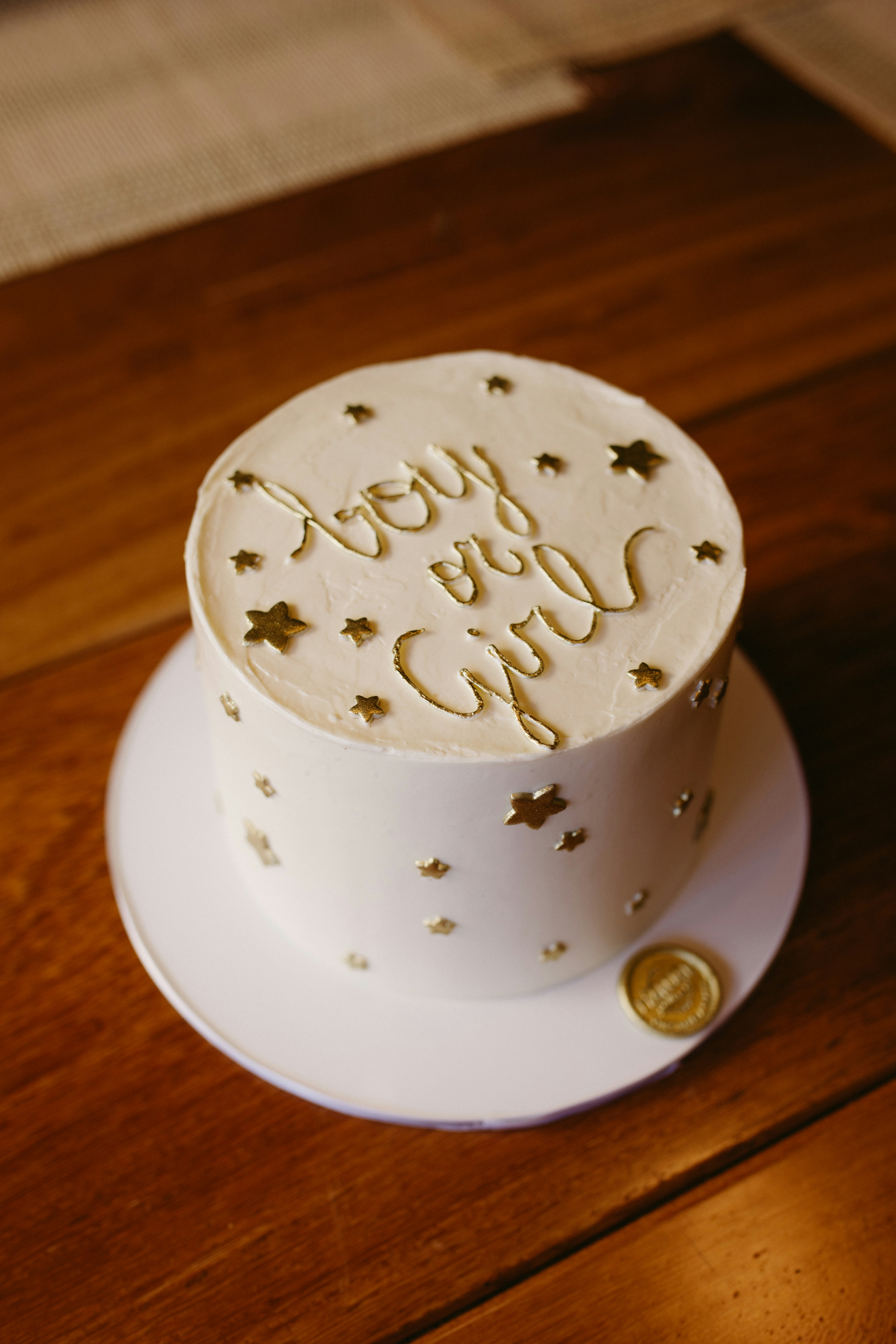 A Creamy Celebration: Star-embellished Cake on a Rustic Table