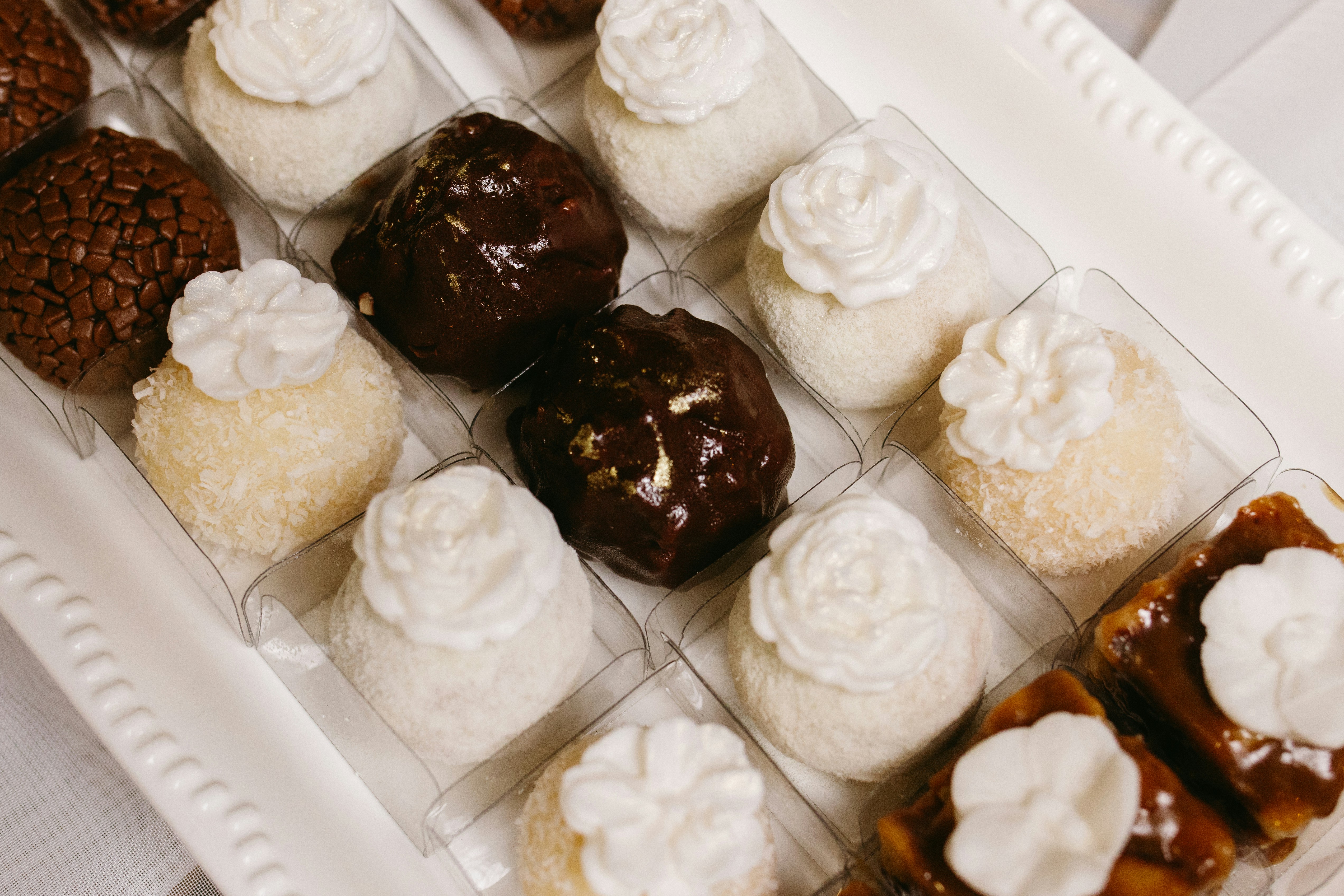 Assorted Chocolates in a White Tray: Creams, Truffles, and Glazed Centers