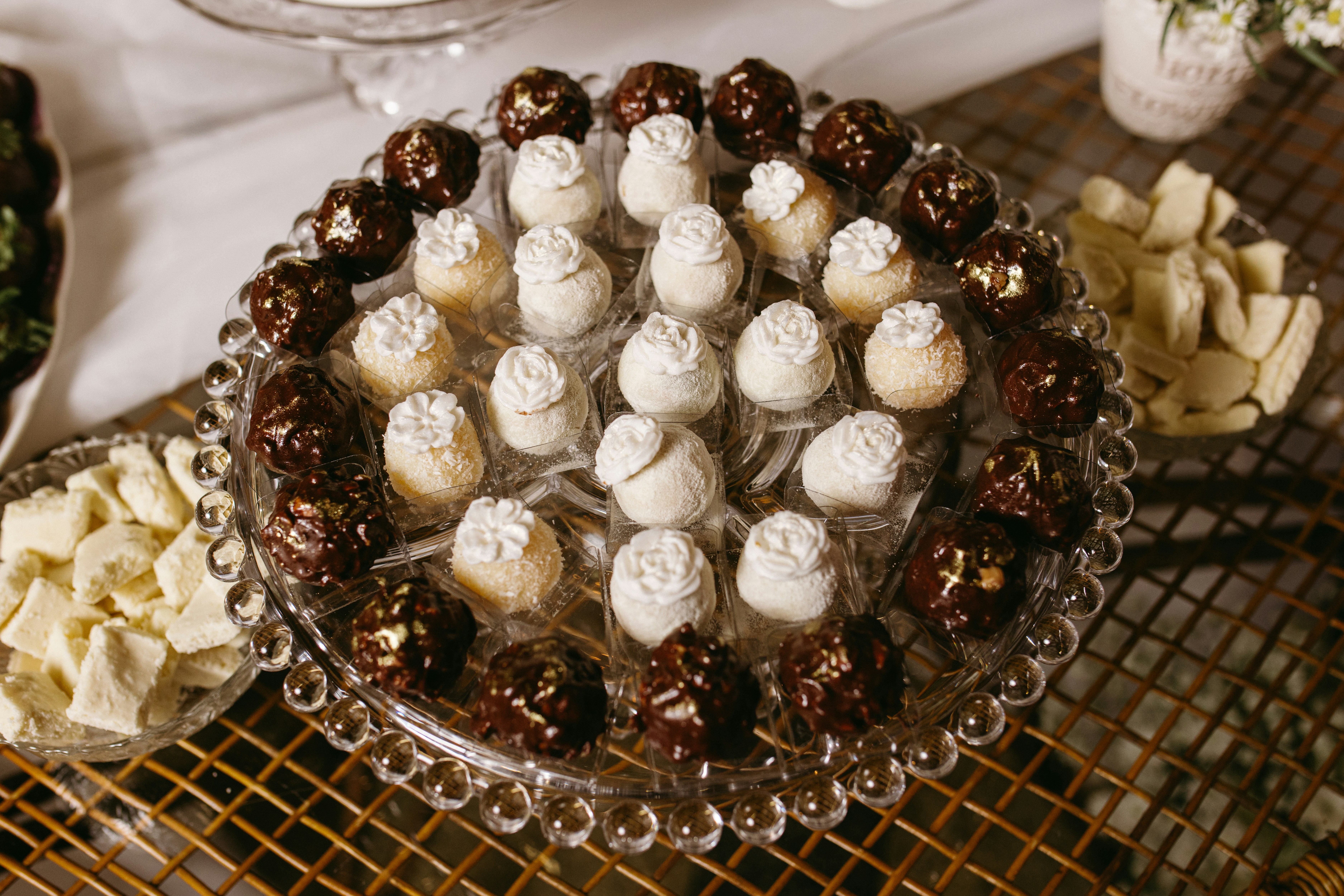 Concentric Crescent: A Ring of White and Dark Mocha Truffles on Glass and Gold