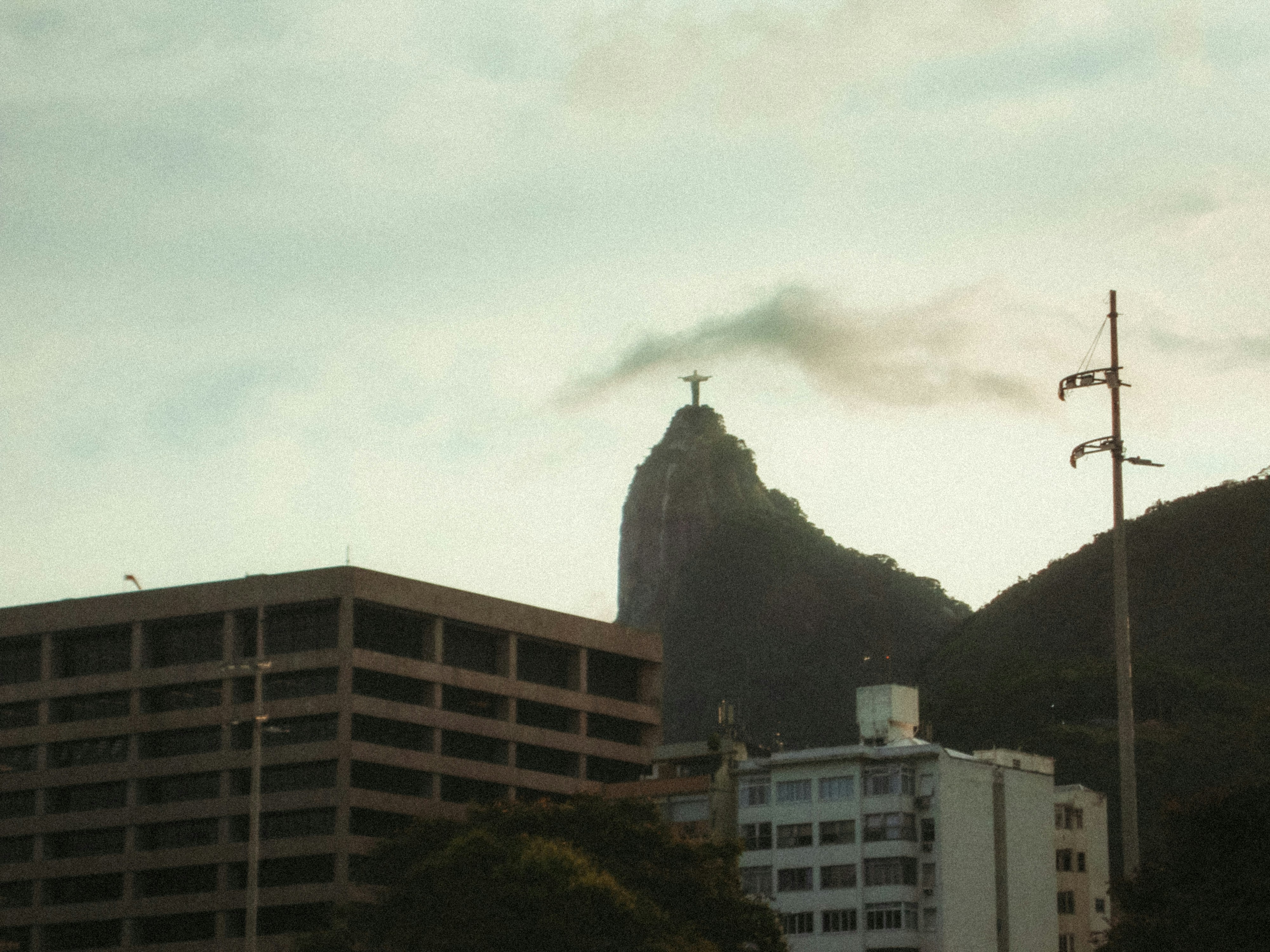 Urban Cascade: Cristo atop a Ridge Over Rio Skyline