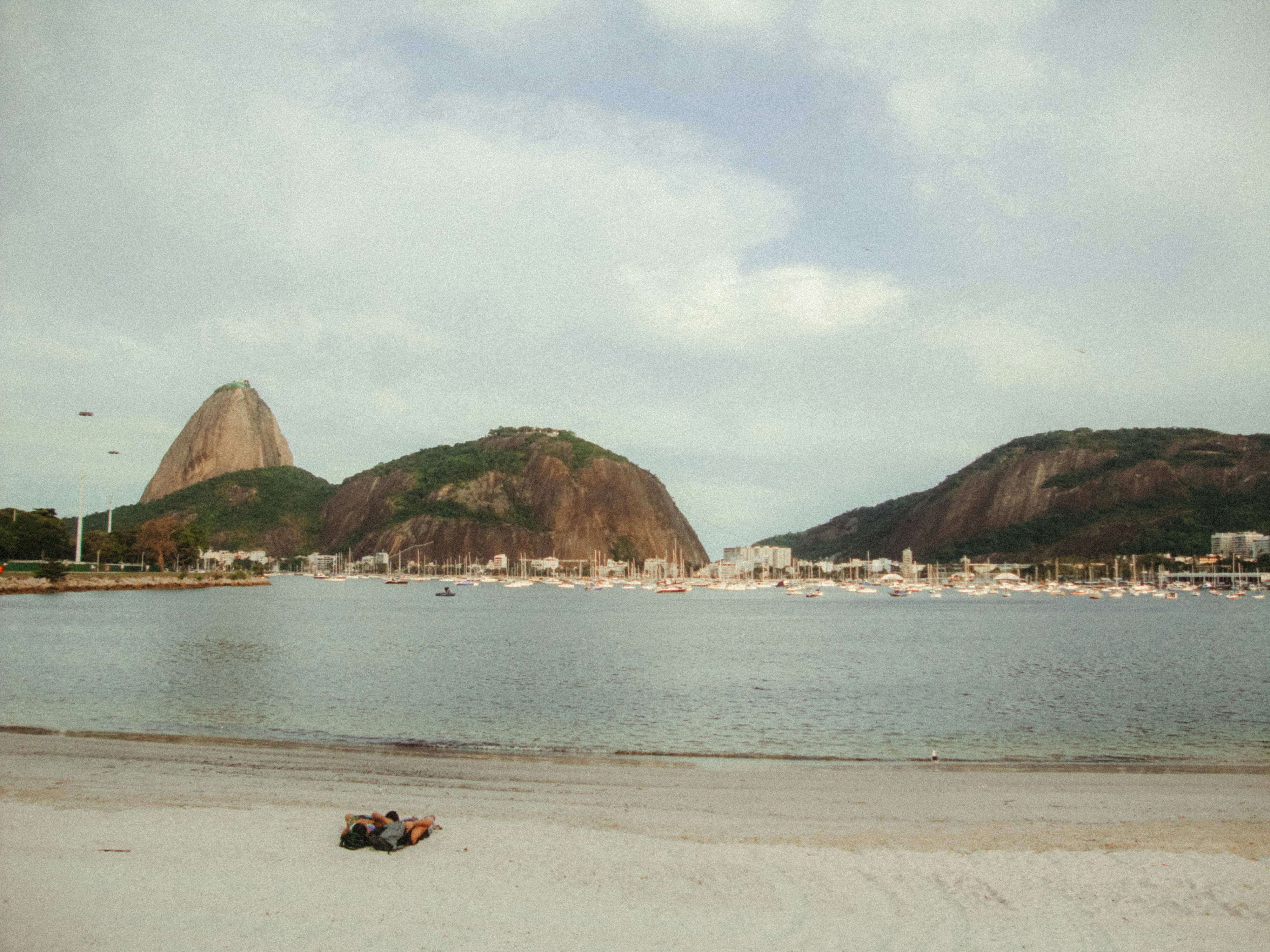 Harbor Calm: Boats at Rest Beneath Sugarloaf-like Rocks