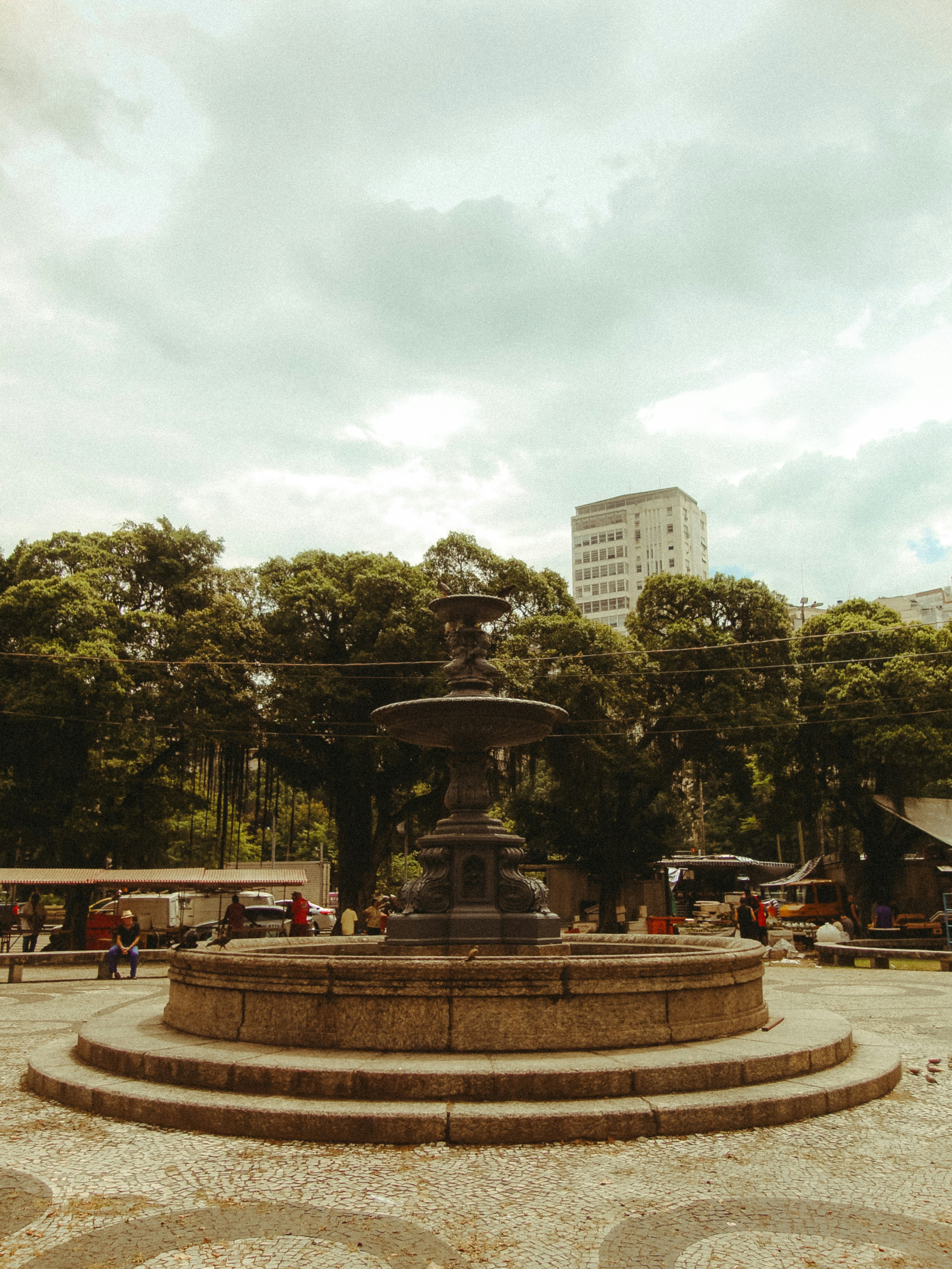 Central Fountain Under Cloudy Sky: A Quiet Urban Square