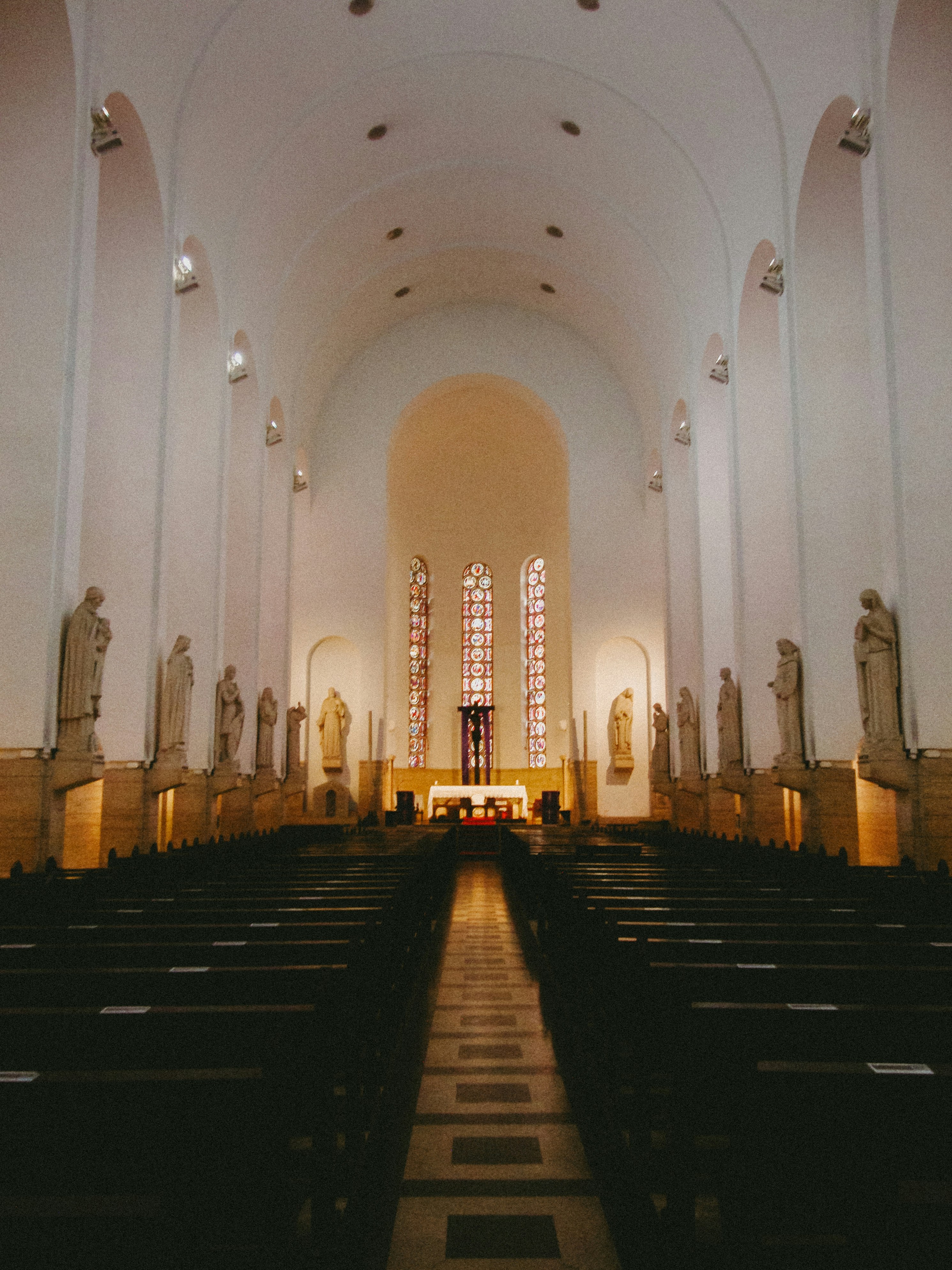 Quiet Aisle Toward the Altar: A Cathedral Interior in Soft Evening Light