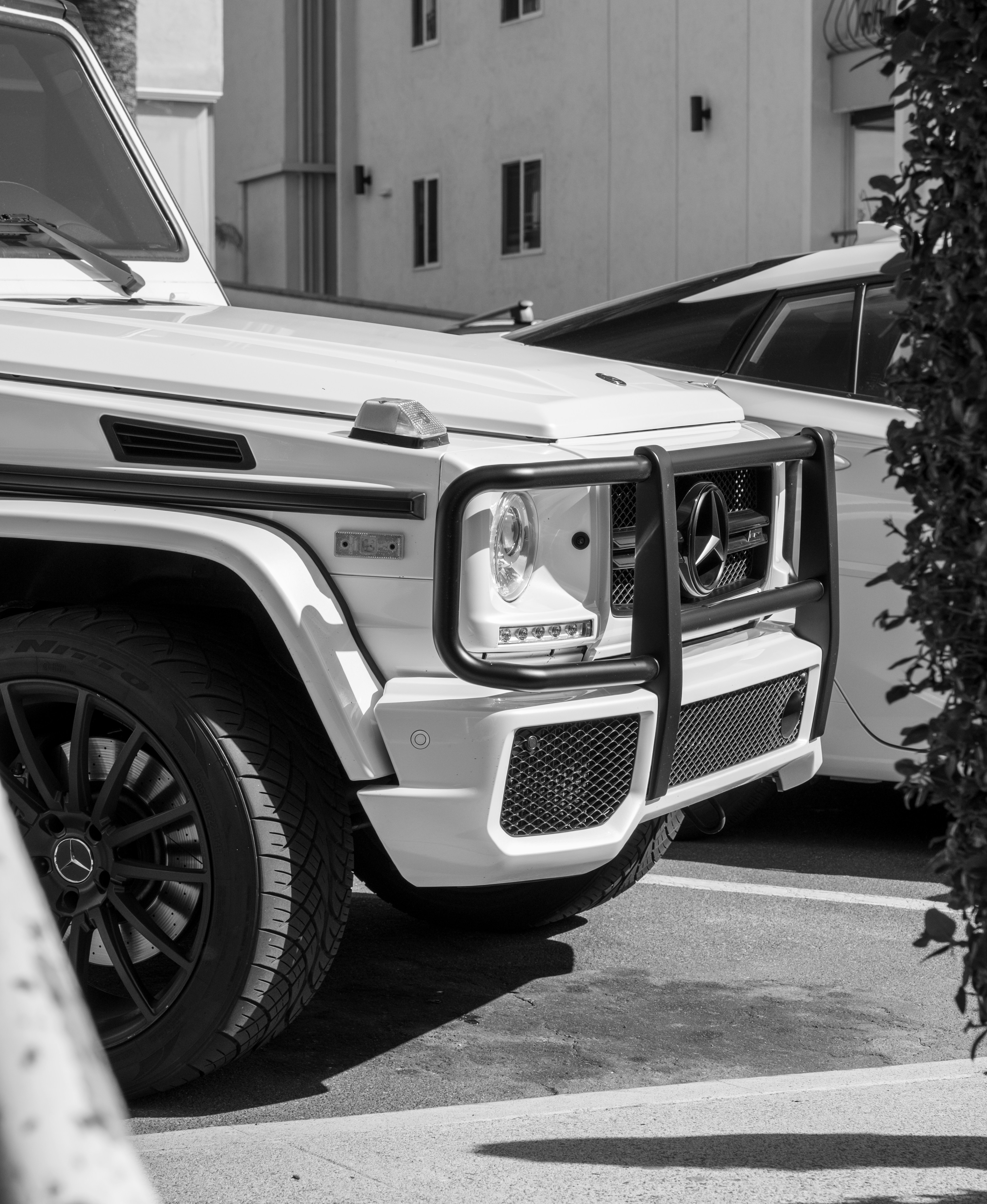 Front-Quarter of a Mercedes-Benz SUV: Bold Grille Guard in a Parking Lot
