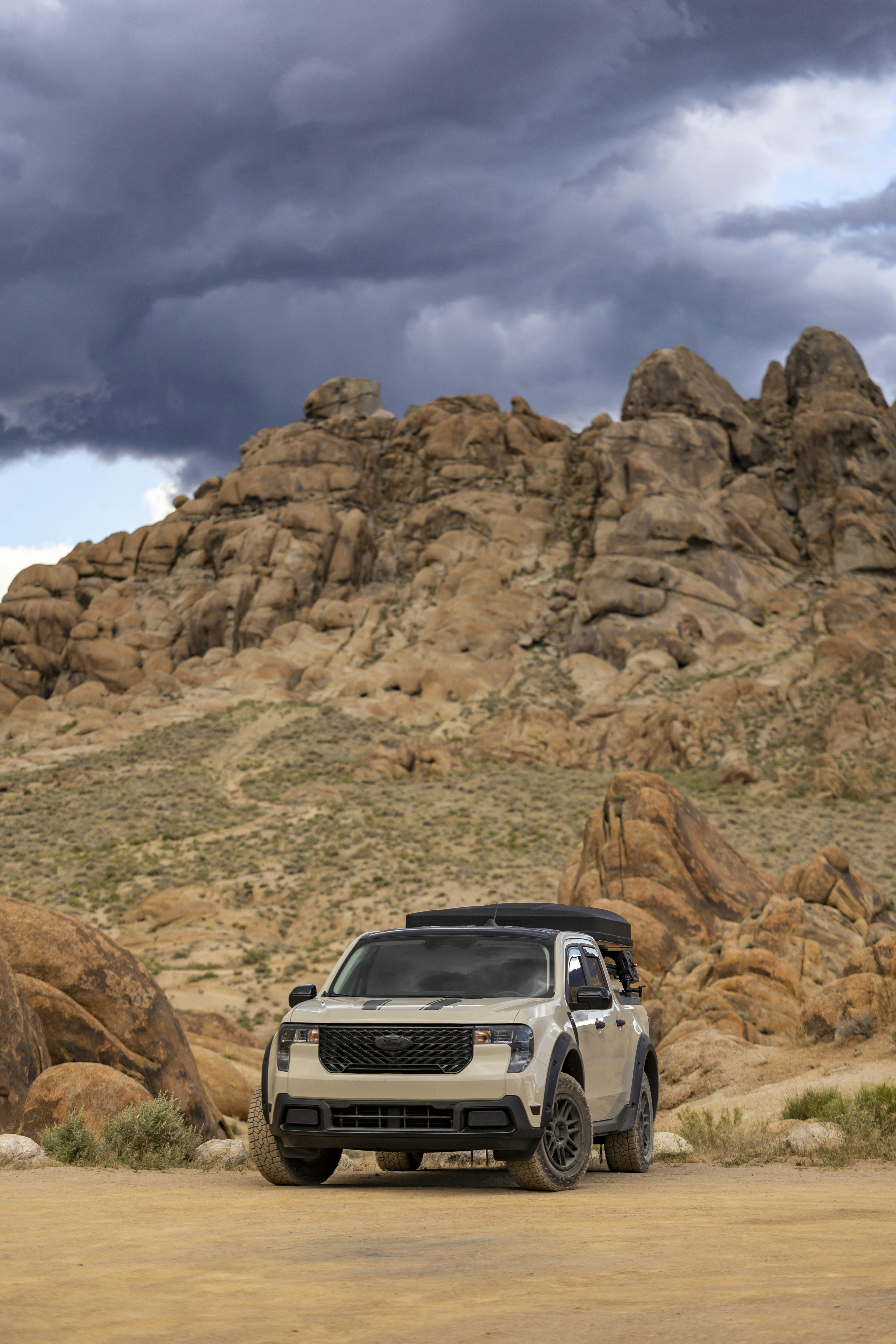 Rugged Desert Odyssey: A Pickup Rests Amid Granite Giants