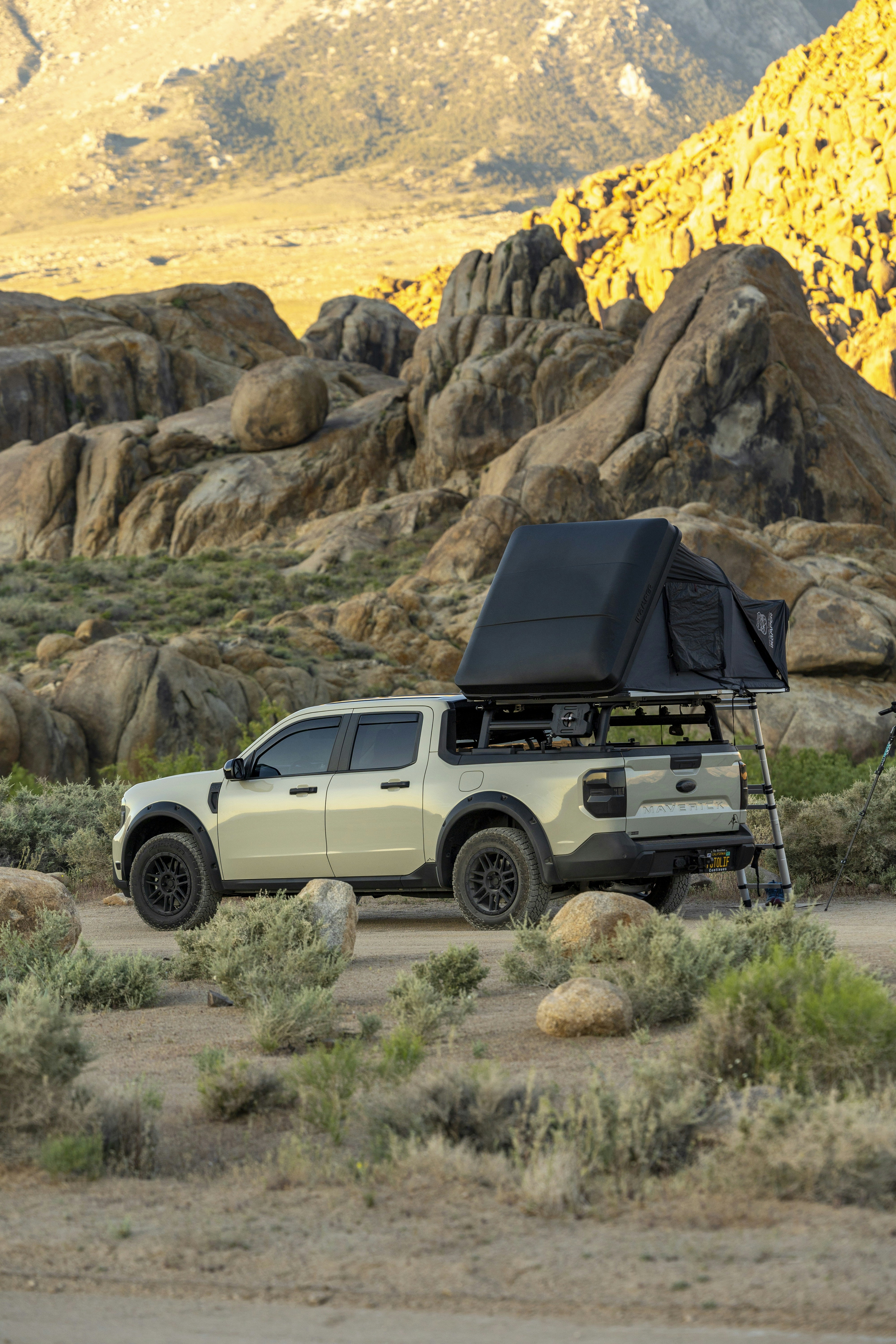 Overlanding Sunrise: A Camp-Top Trailer Rises Above Desert Rock