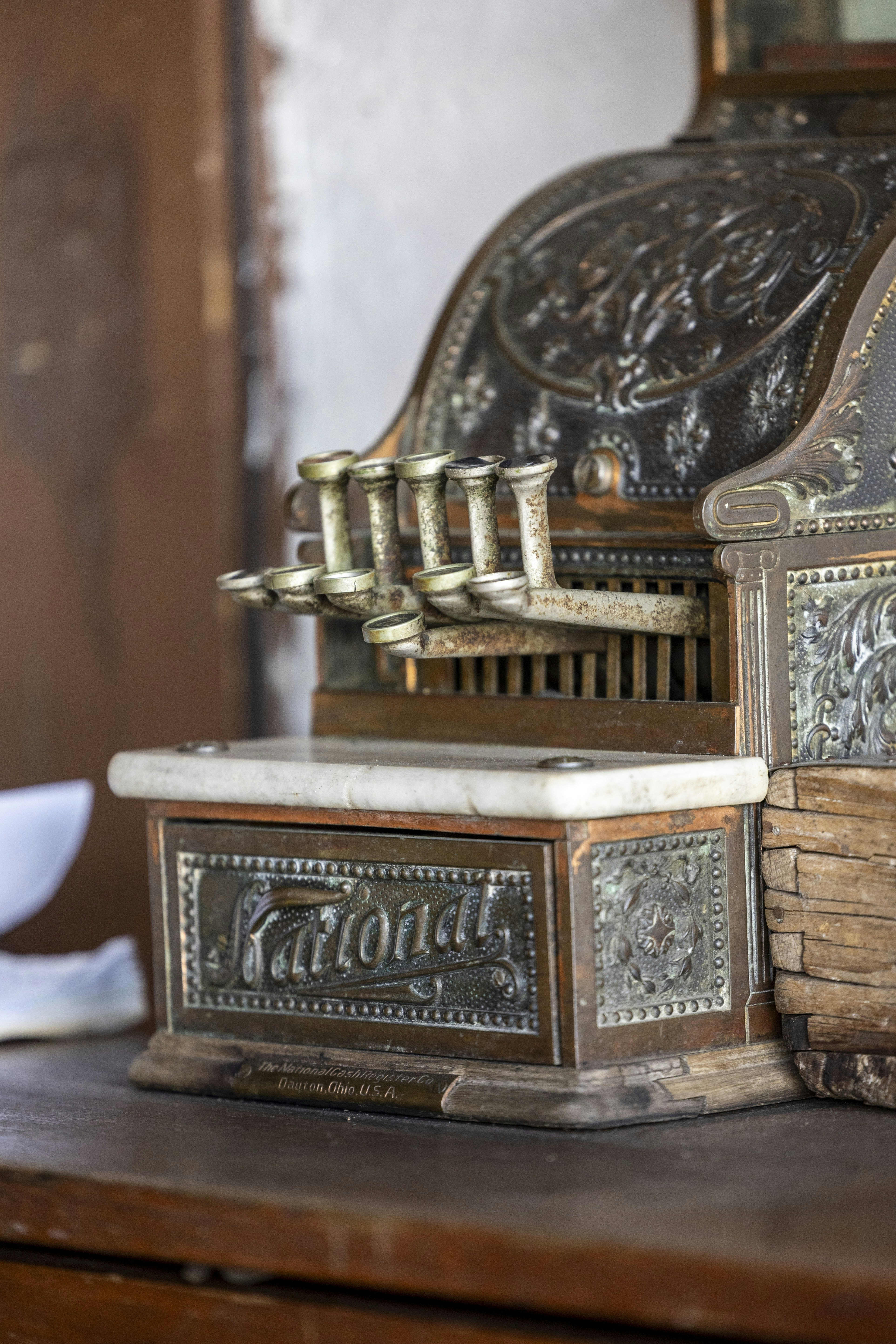 Antique Cash Register in Weathered Wood Setting
