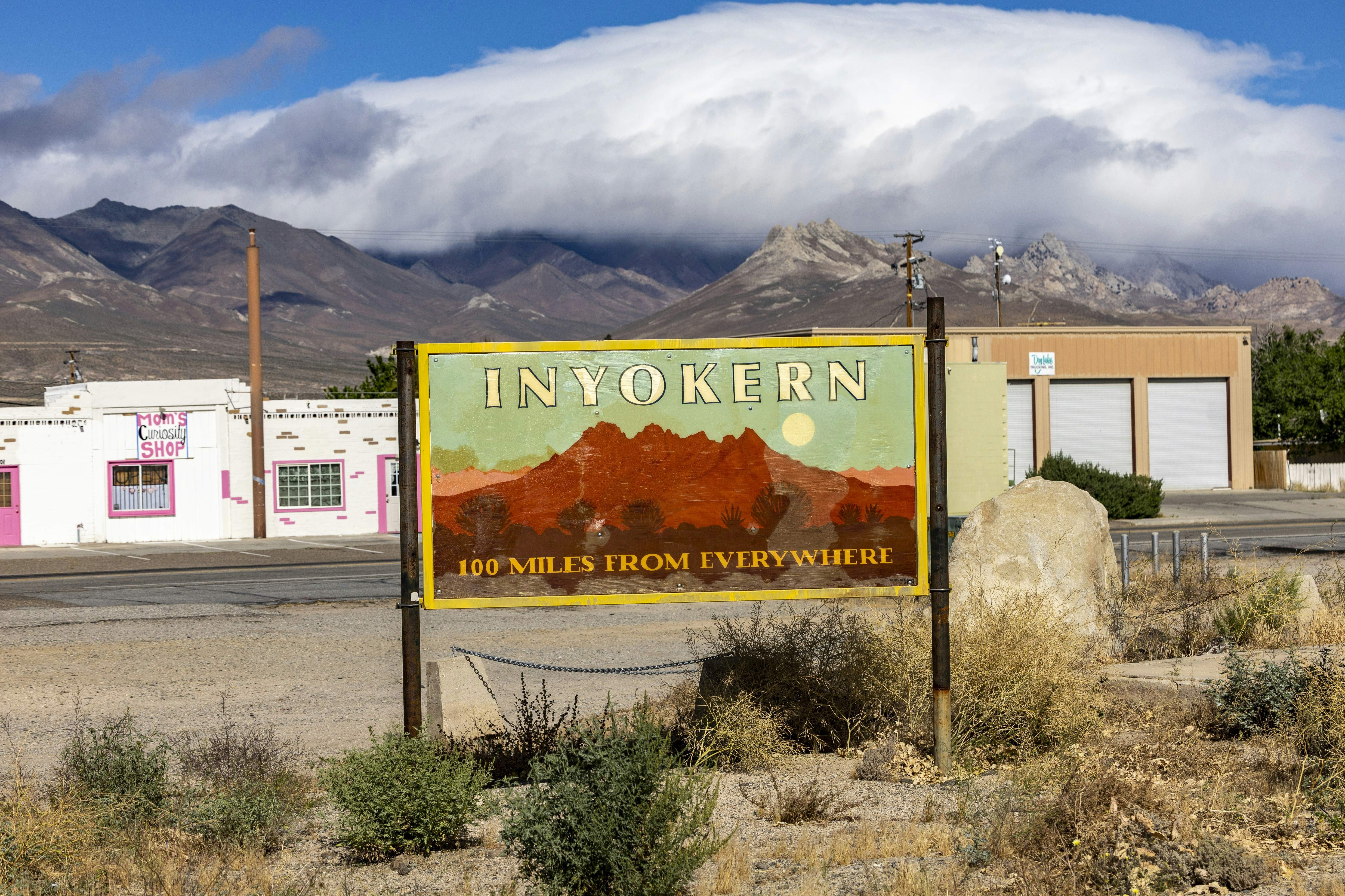 Desert Welcome: INYOKERN Sign Amid Mountain Crest