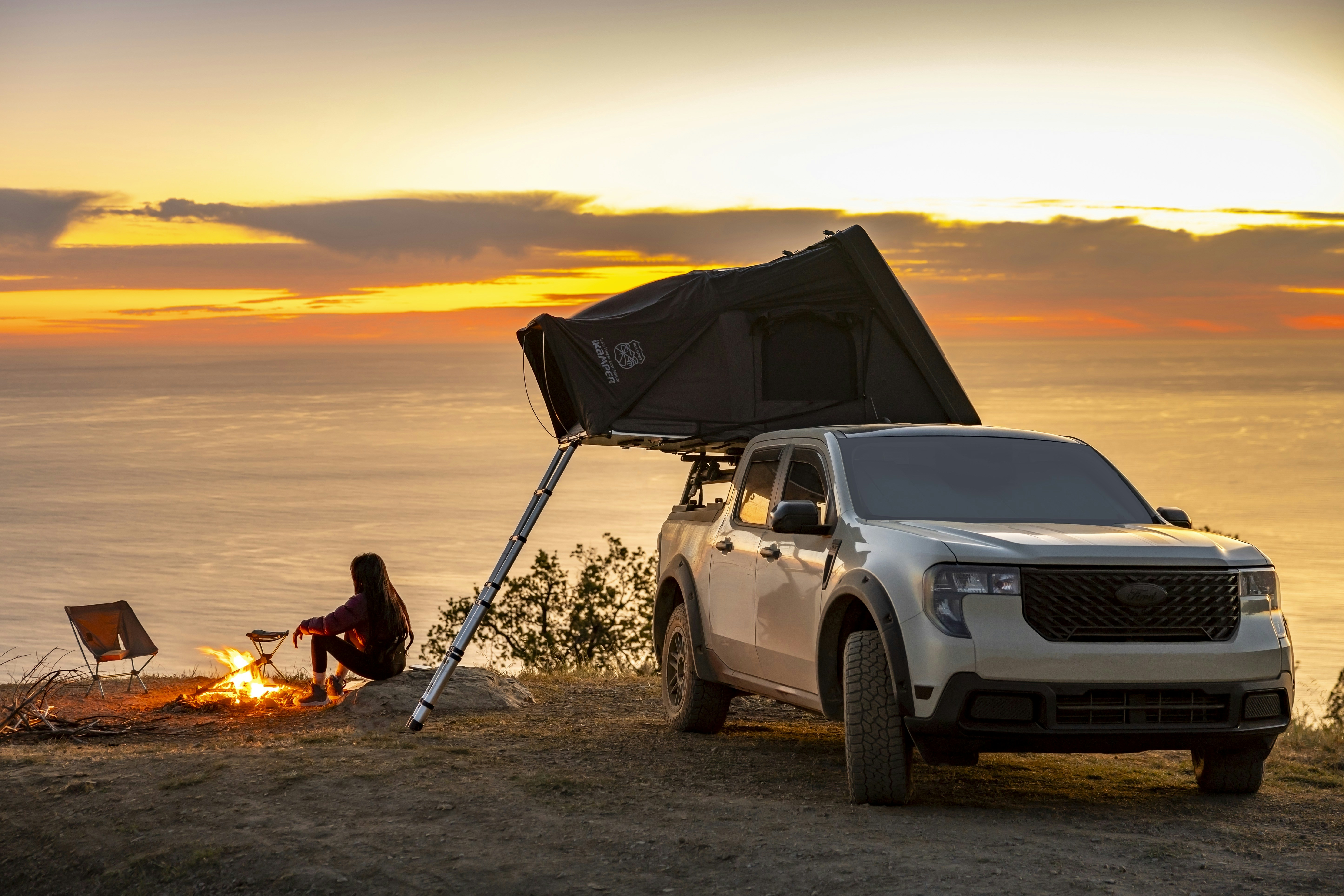 Sunset Camp: Truck Tent and Campfire by the Cliffside