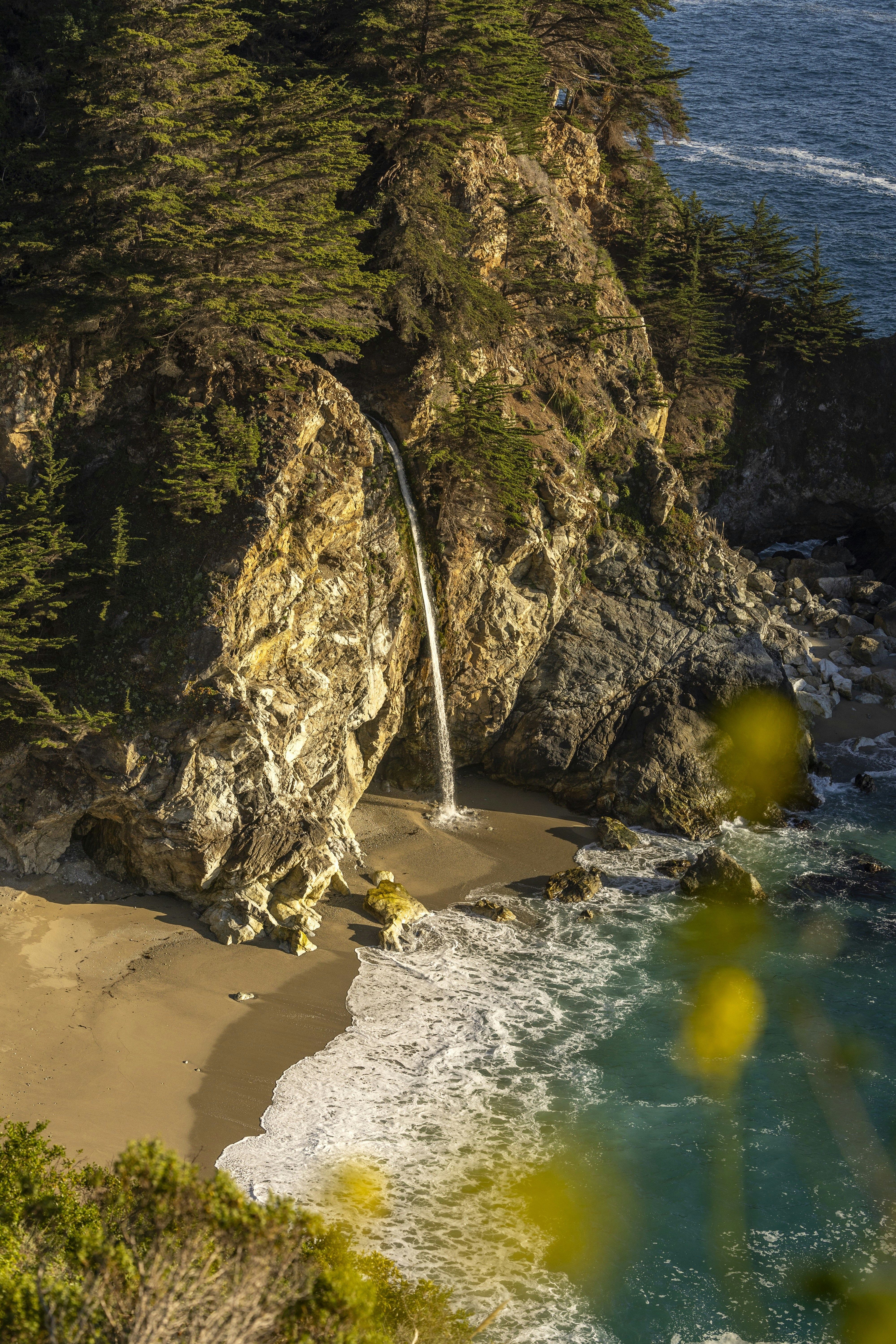 Sea Spray Cascades: A Hidden Beach Beside a Cliffside Waterfall