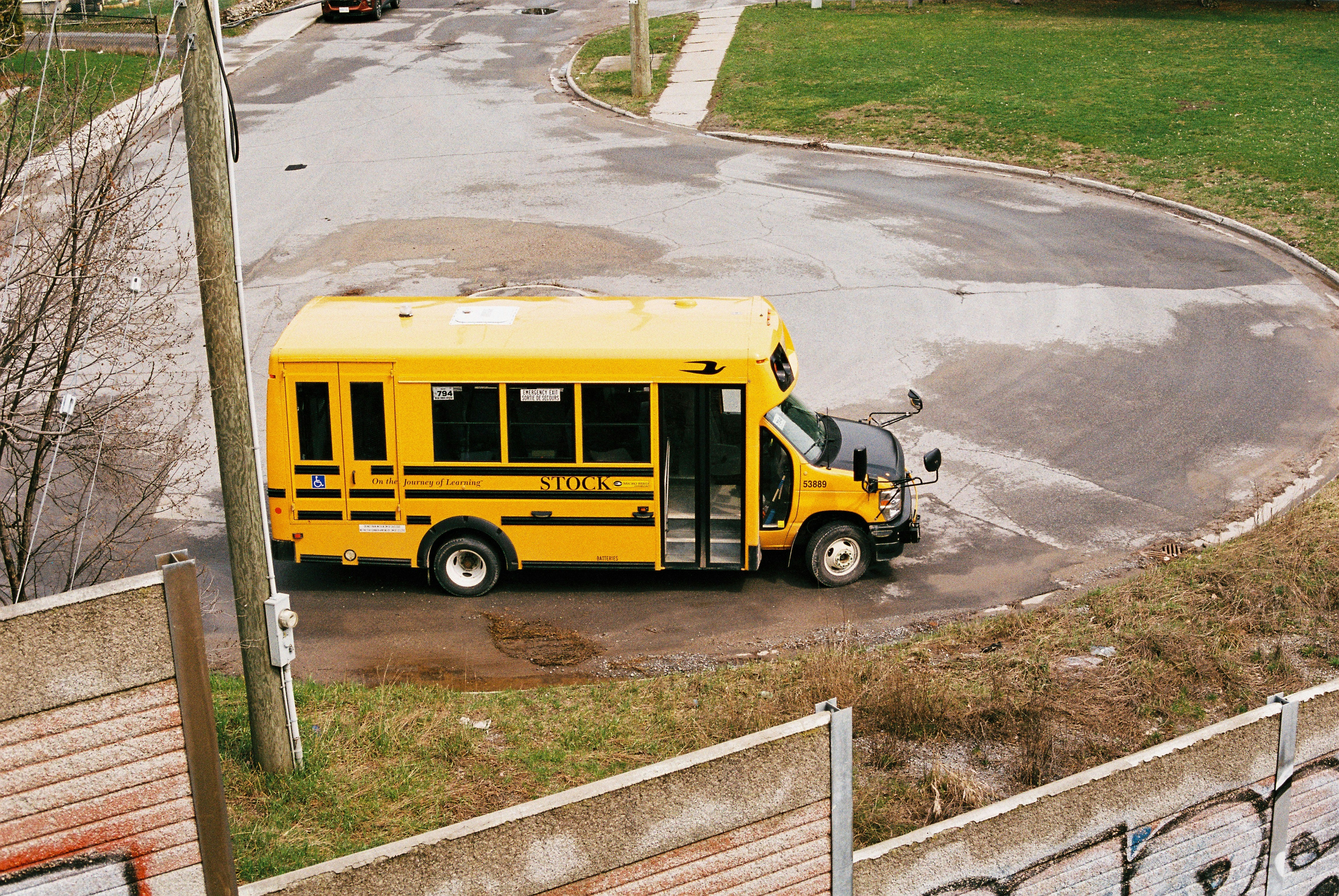 Yellow School Bus Resting at a Curve, Aerial View Overlook