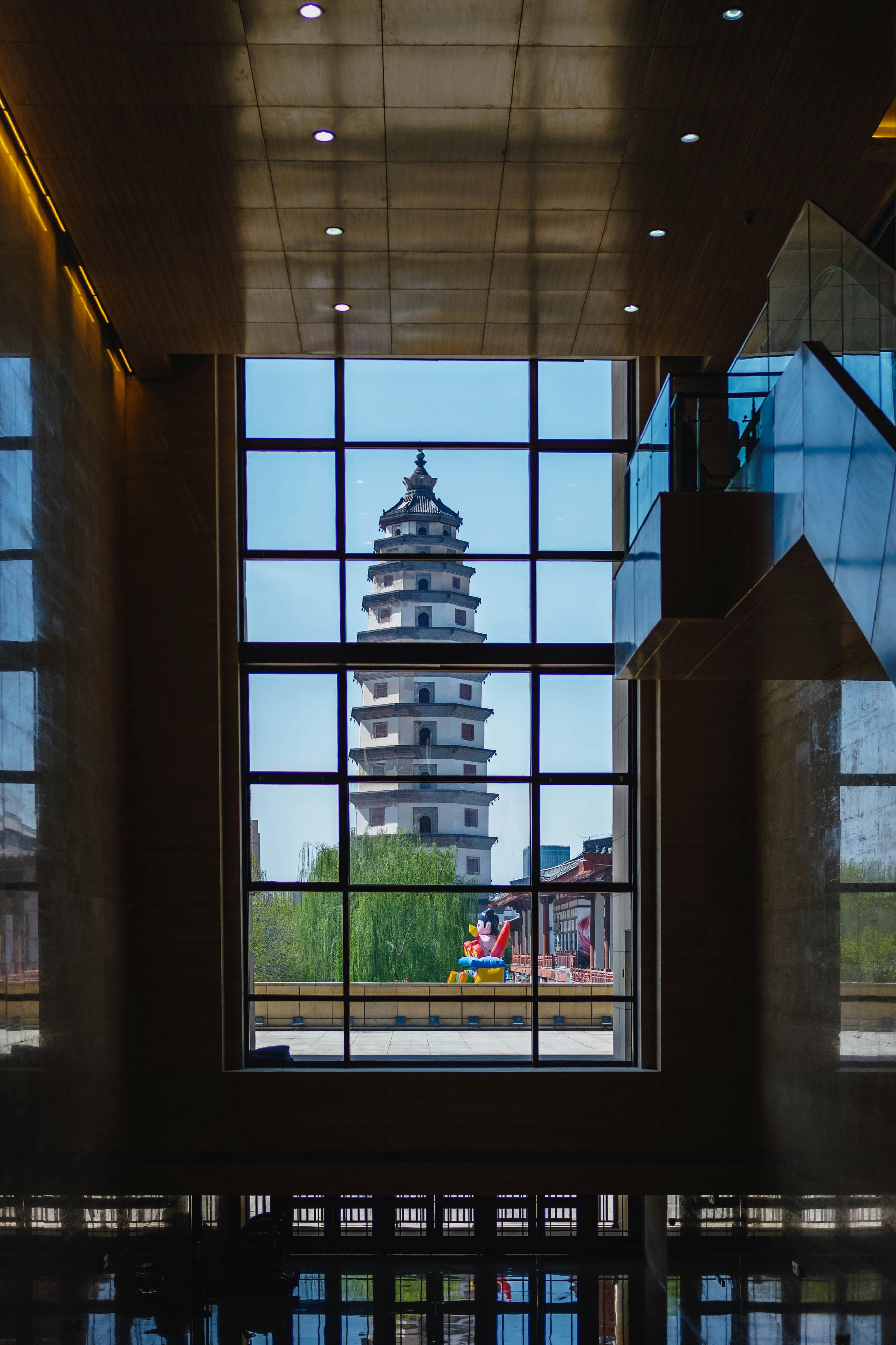 Through the Glass Tower: A Pagoda Framed by Modern Glass