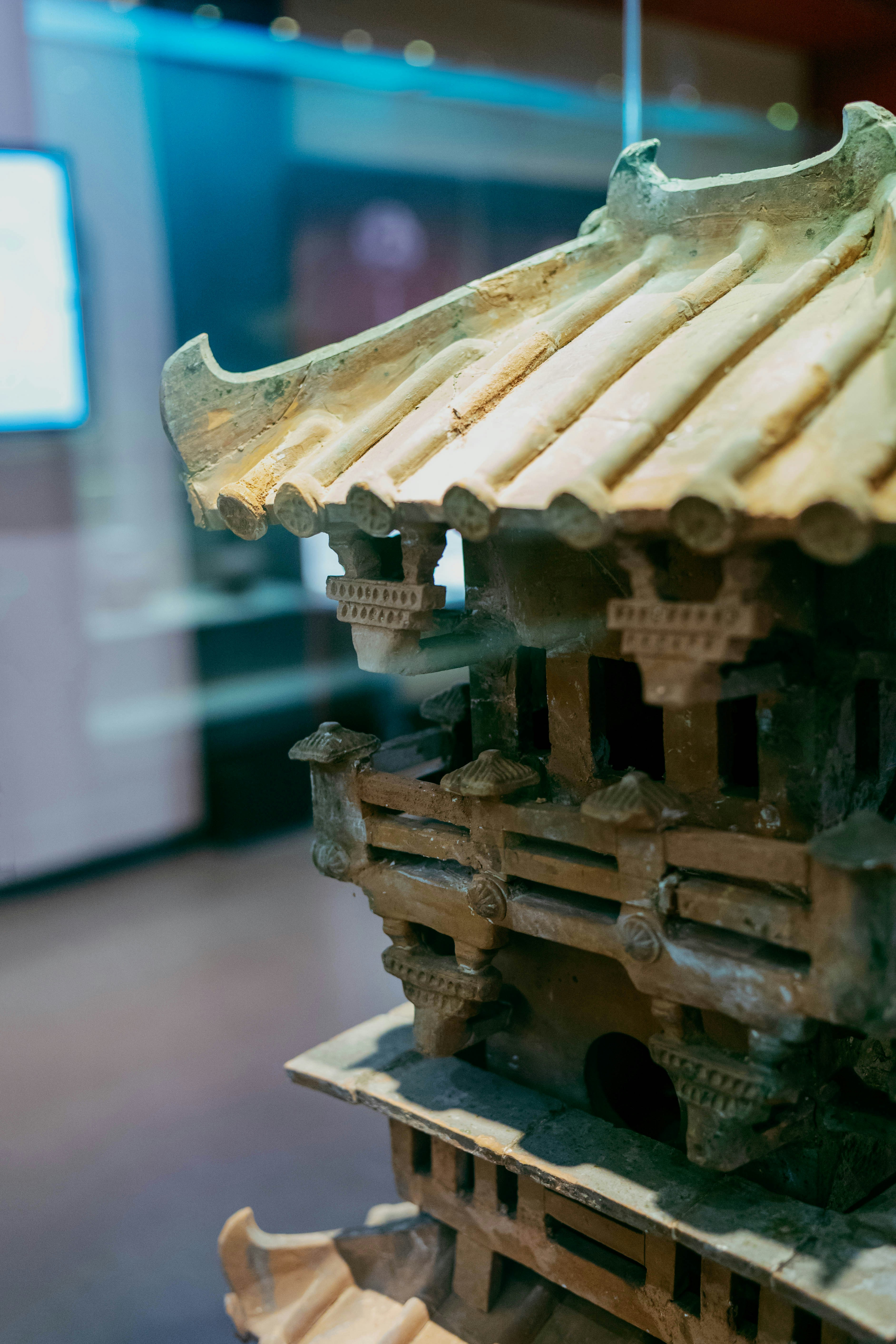 Miniature Temple in Focus: A Weathered Roof and Wooden Structure