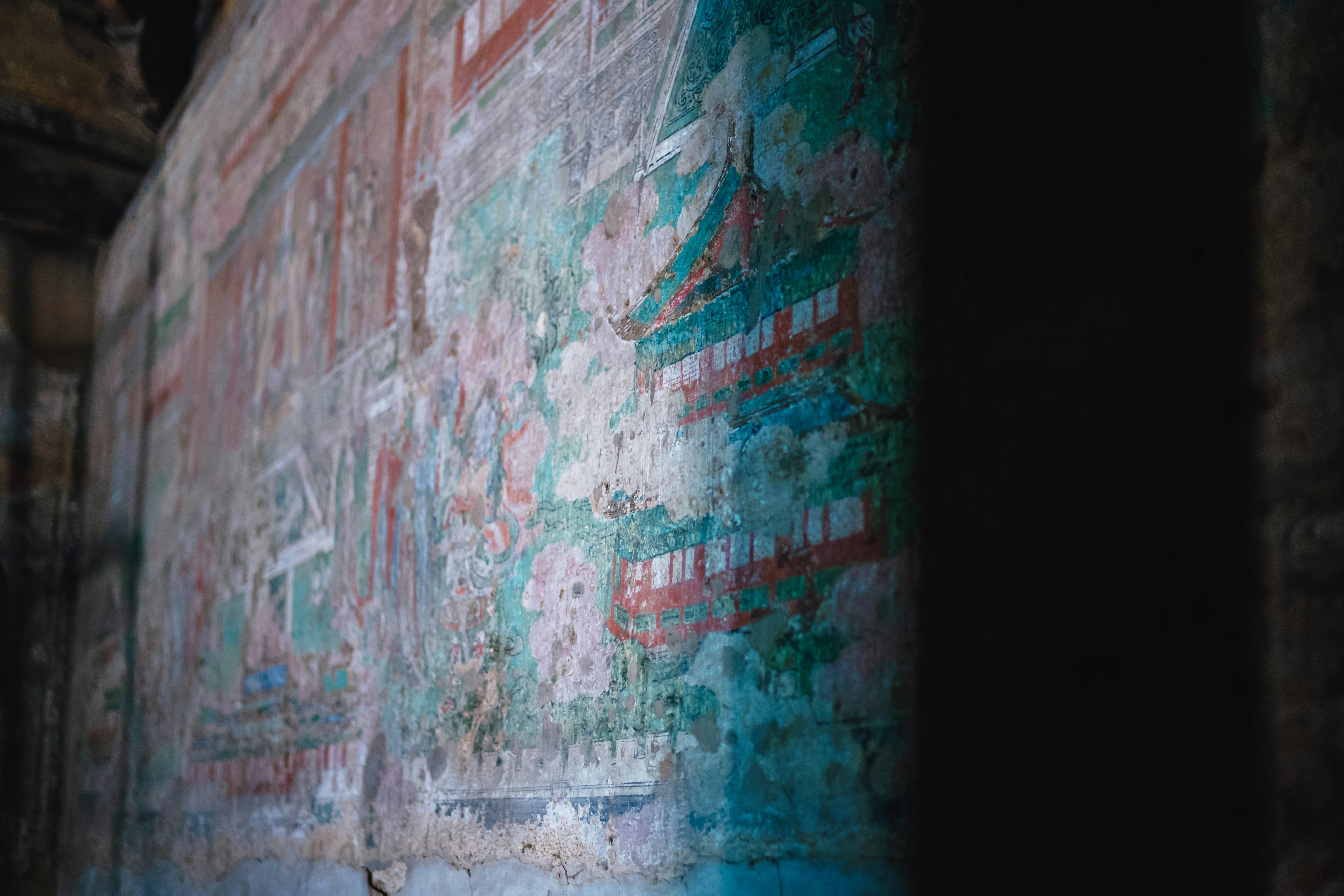 Faded Advertisements on a Weathered Brick Wall