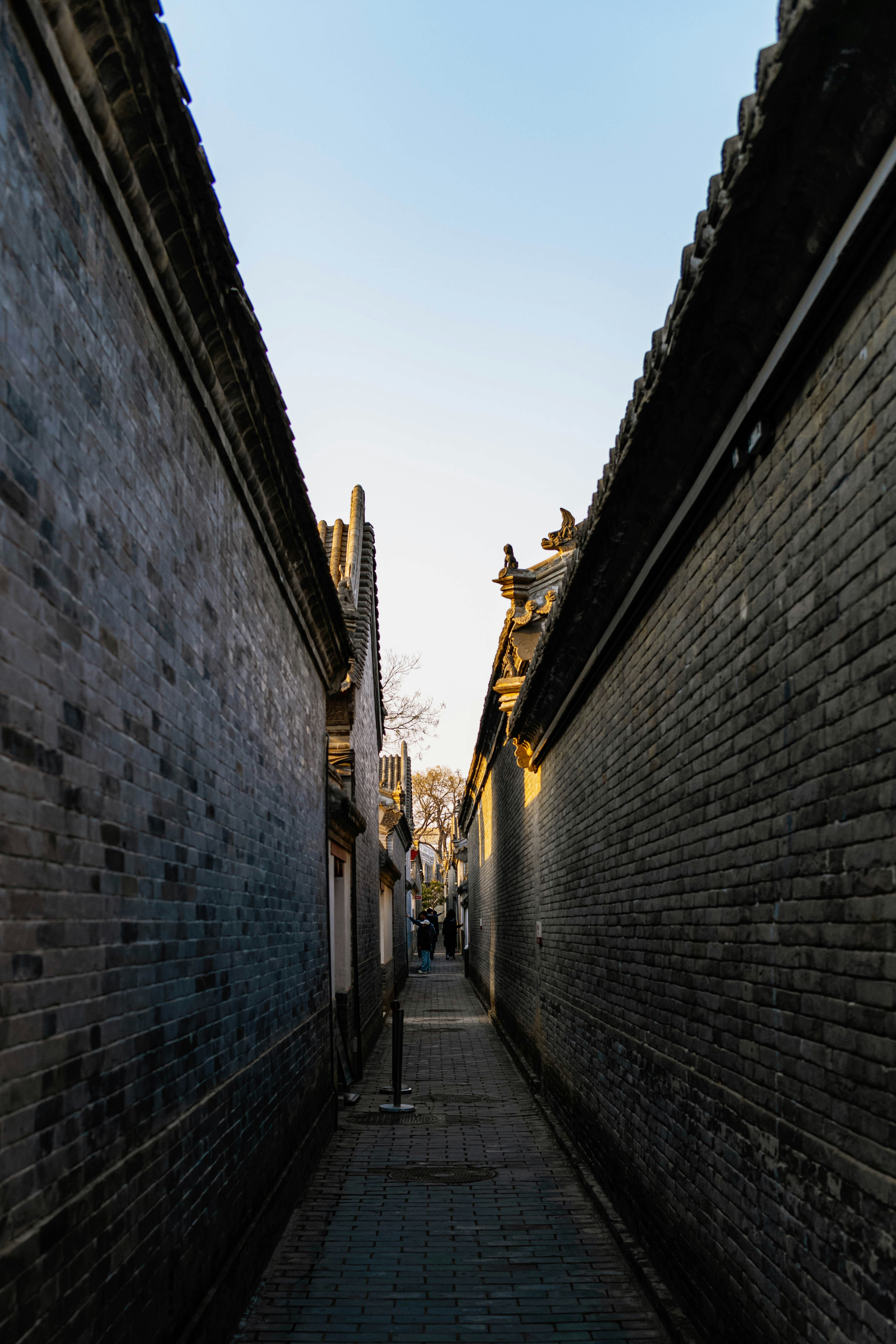 Sunlit Alleyways: Lanterns, Walls, and the Quiet Path Ahead