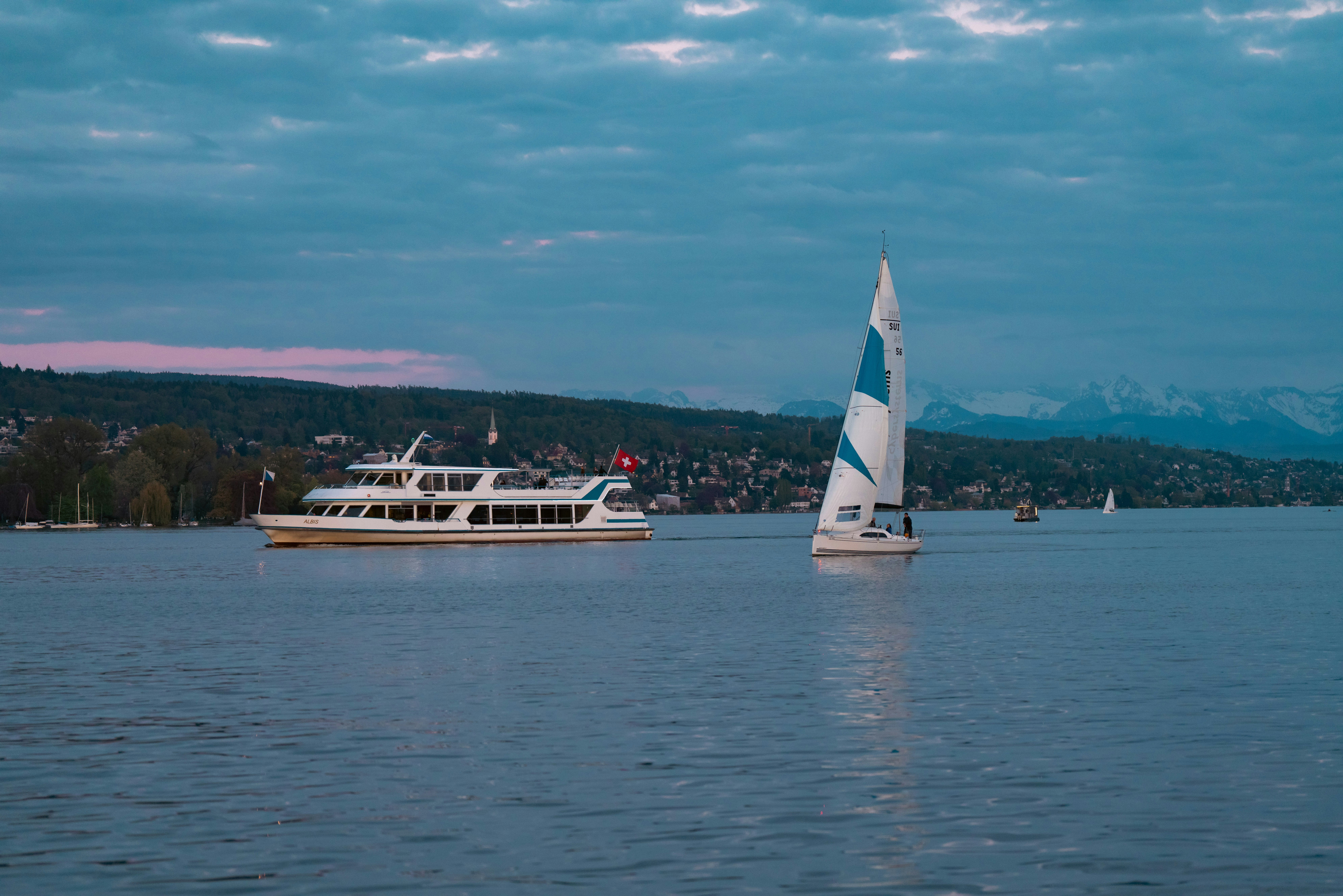 Sail and Steam: Boats Treading a Quiet Lake
