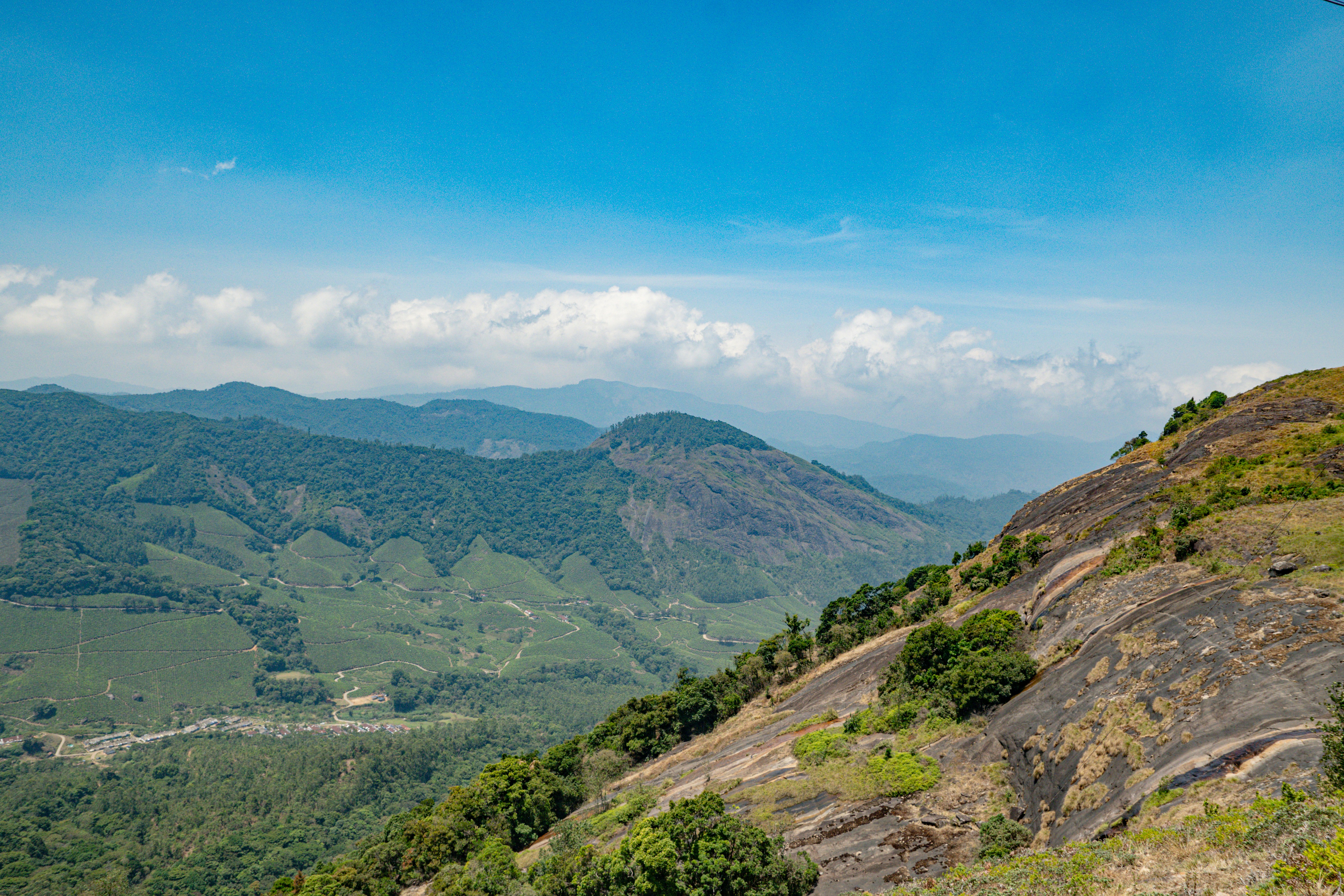 Sunlit Ridge: A sweeping hillside under a clear blue dome