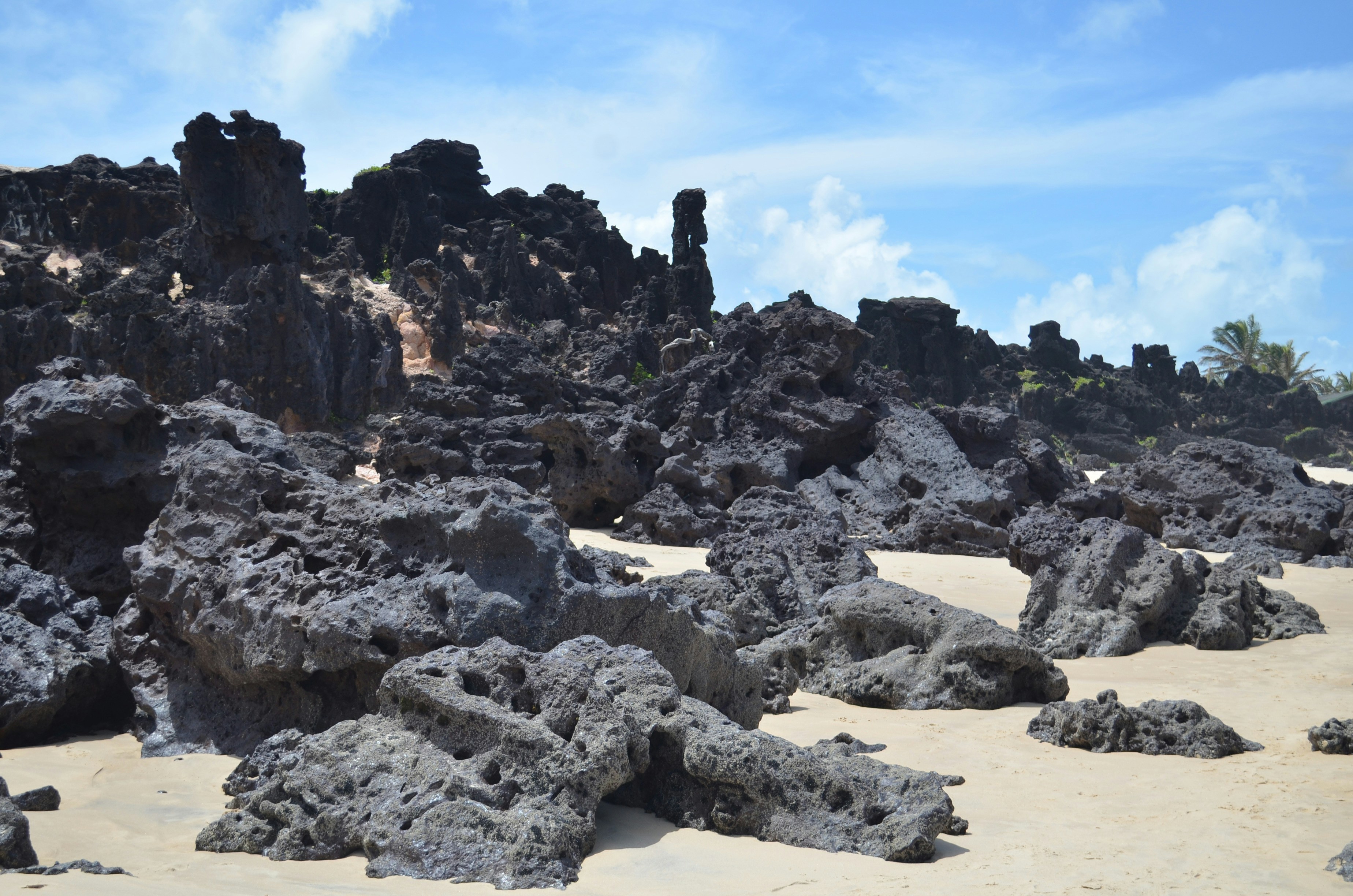 Lava-like Granite Promontory Framed by Sand and Sky