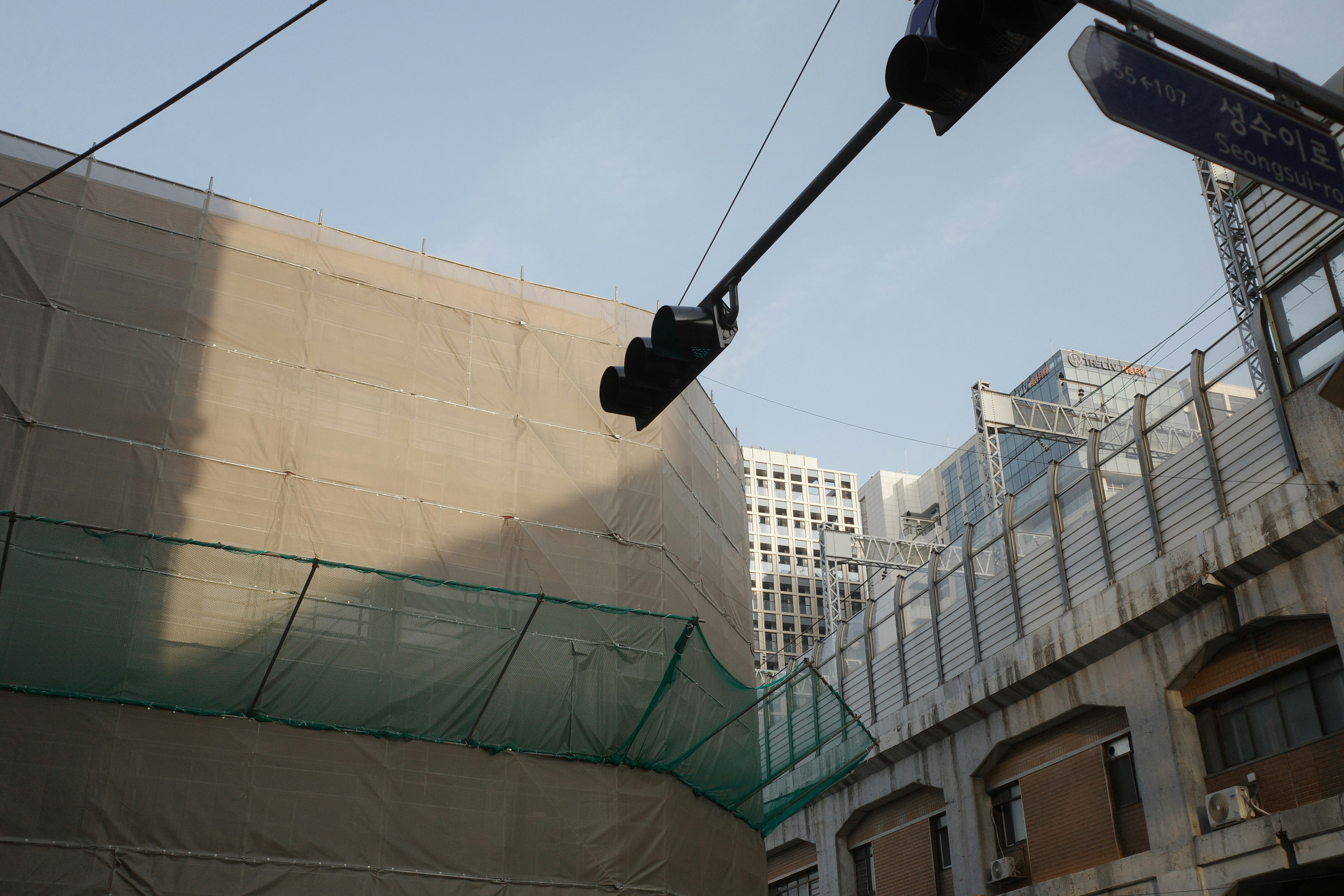 Urban Construction Shadows Under a Sky-Blue Noon