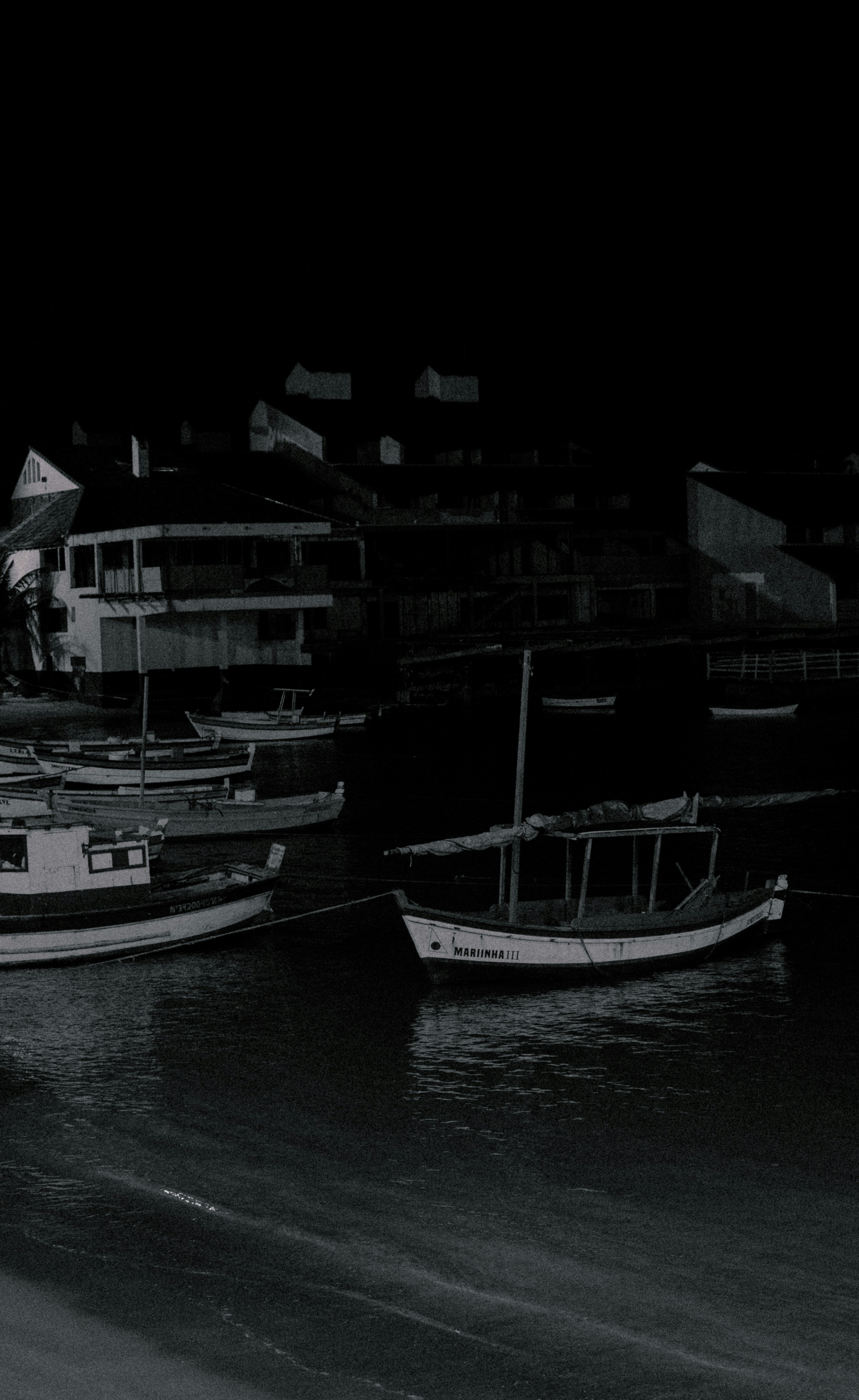 Moonlit Wharf: Boats Quietly Rest on Stilled Water