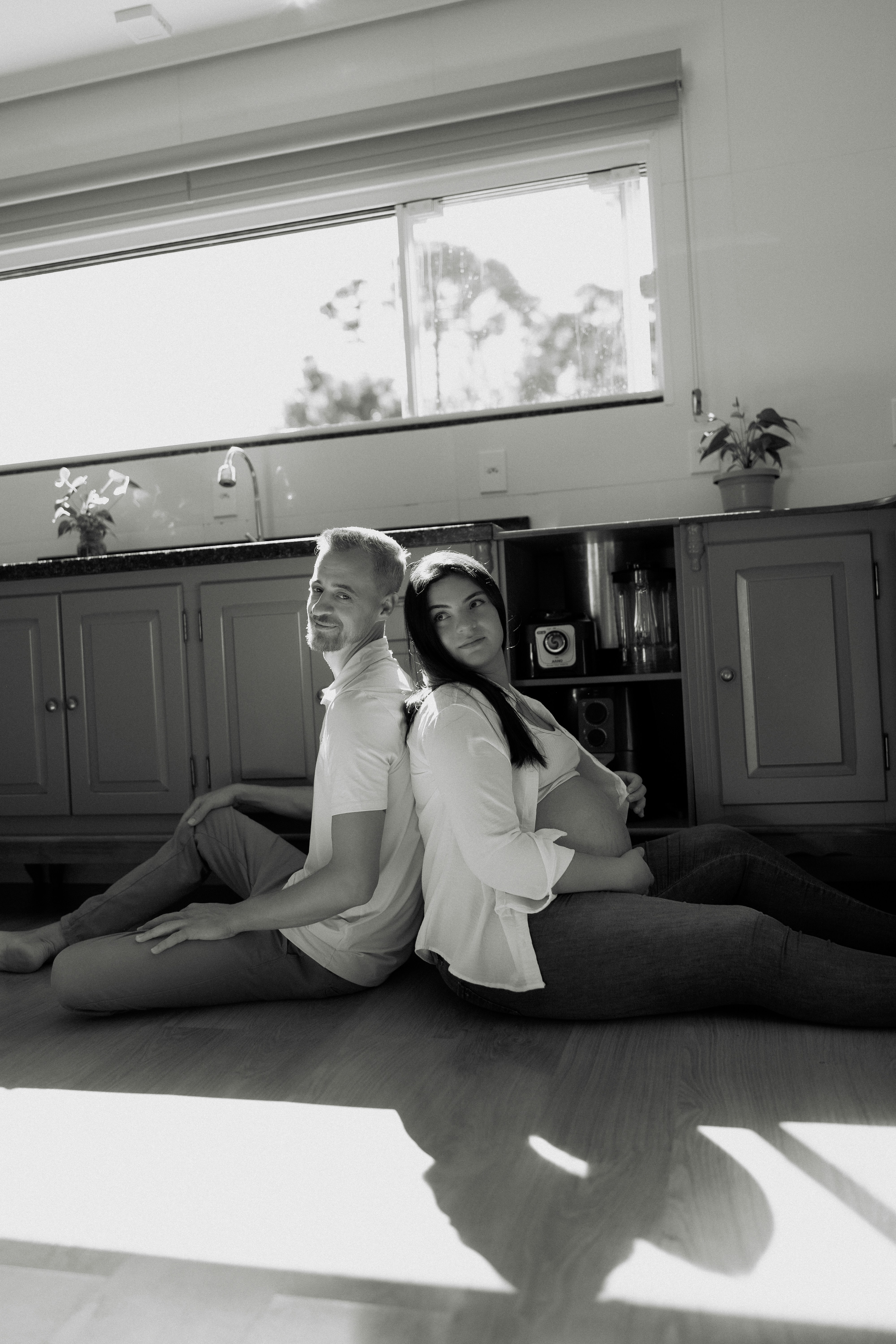 Growing Together: Expectant Moment Shared in Sunlit Kitchen