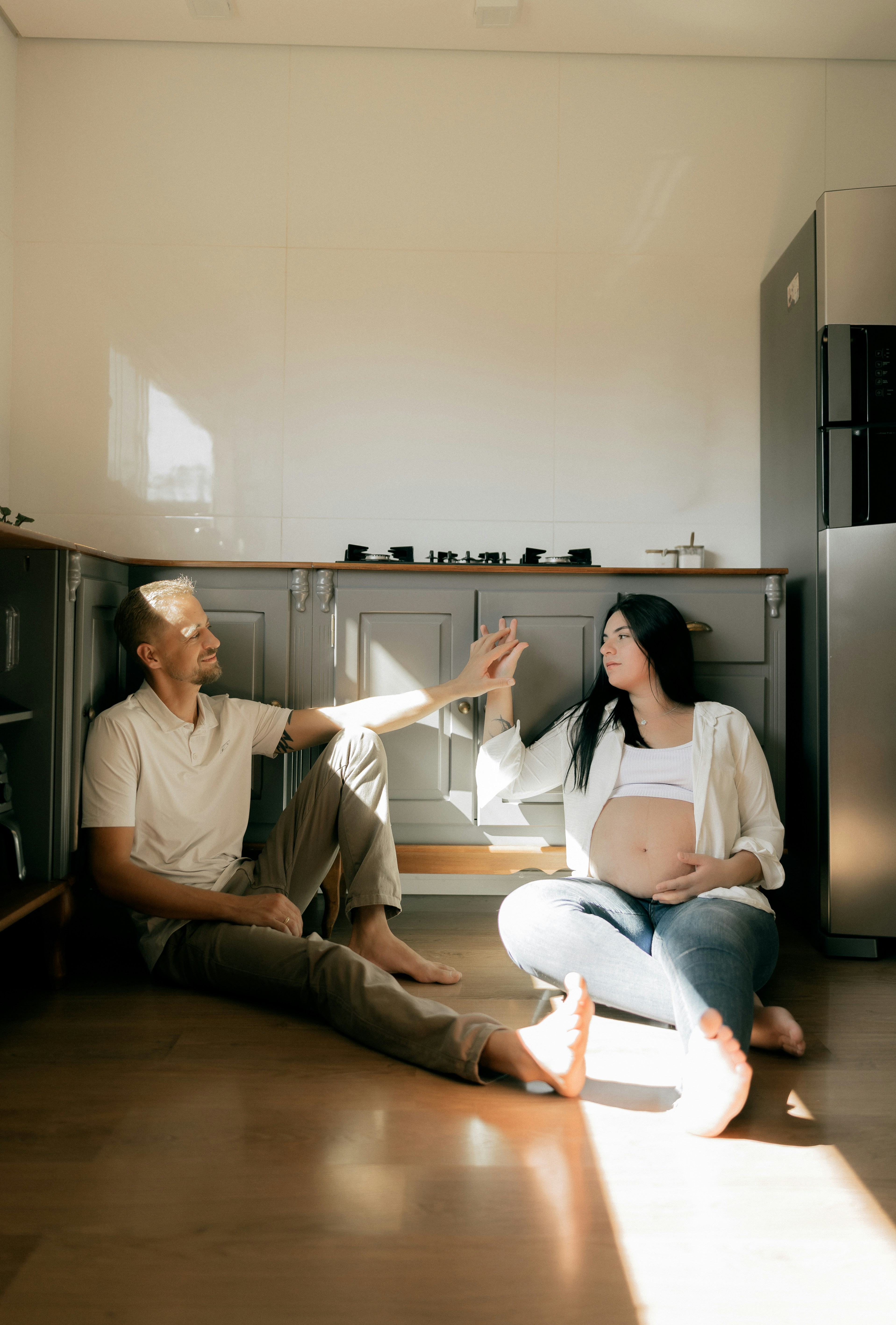 Household Harmony: A Quiet Moment of Expectant Connection in the Kitchen