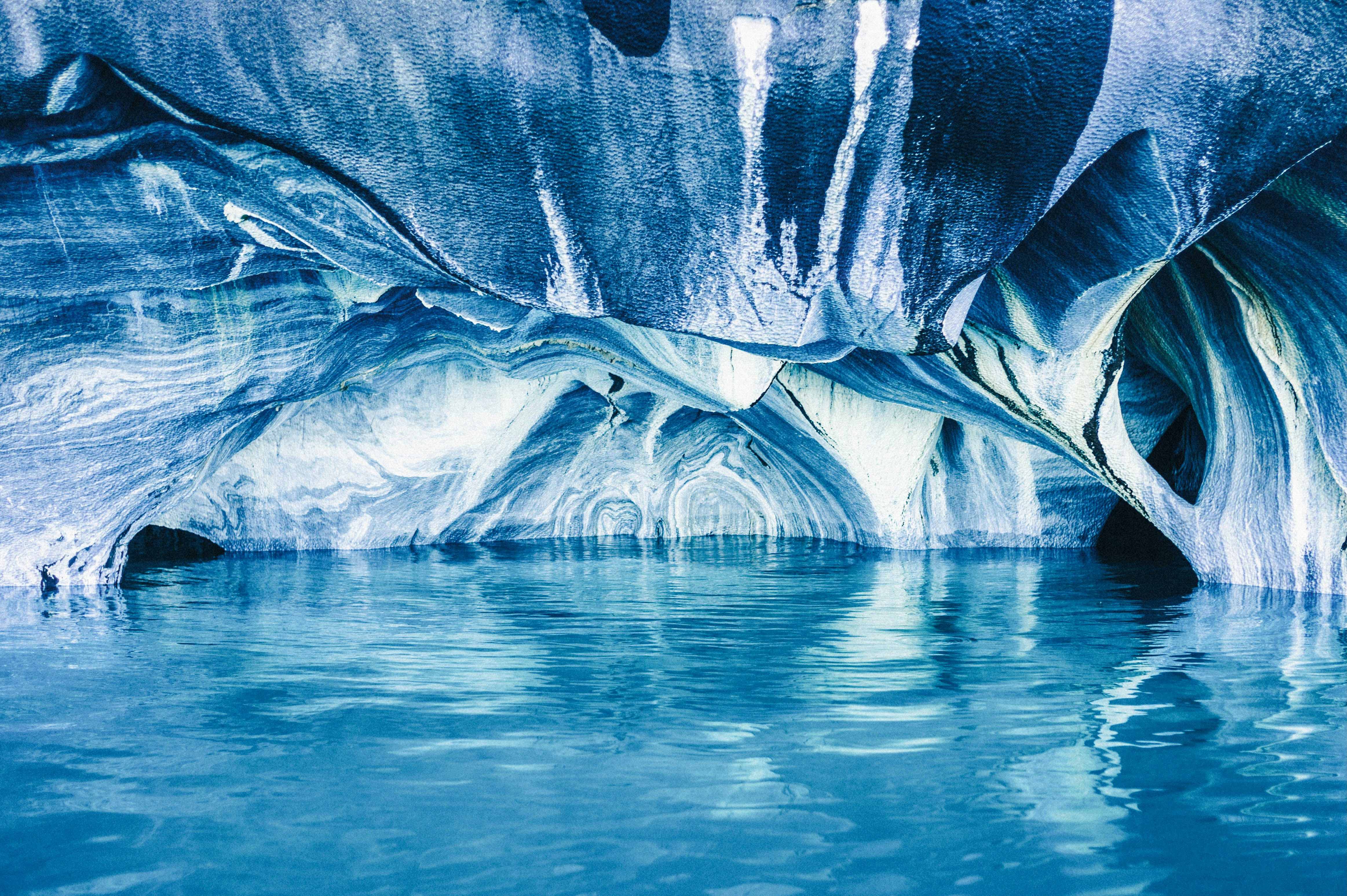 Blue marble cave with calm water reflecting patterns photo – Free ...