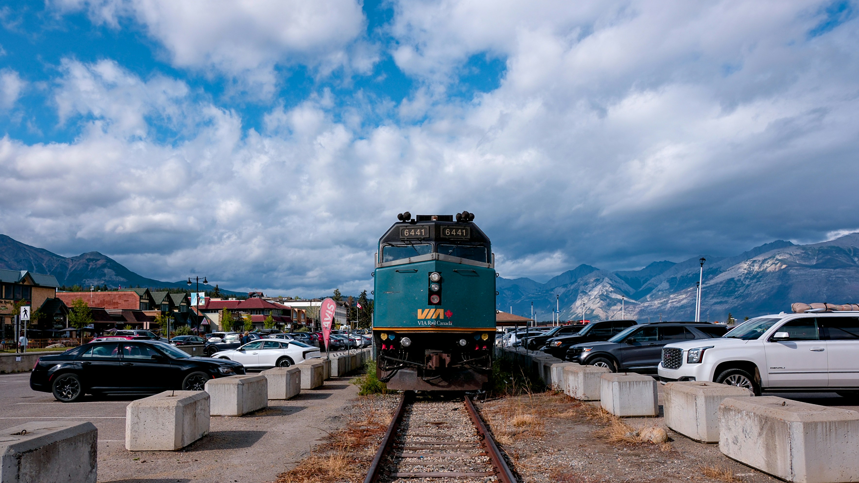 Locomotive at the Platform: Centered Power Amid Mountain Backdrop