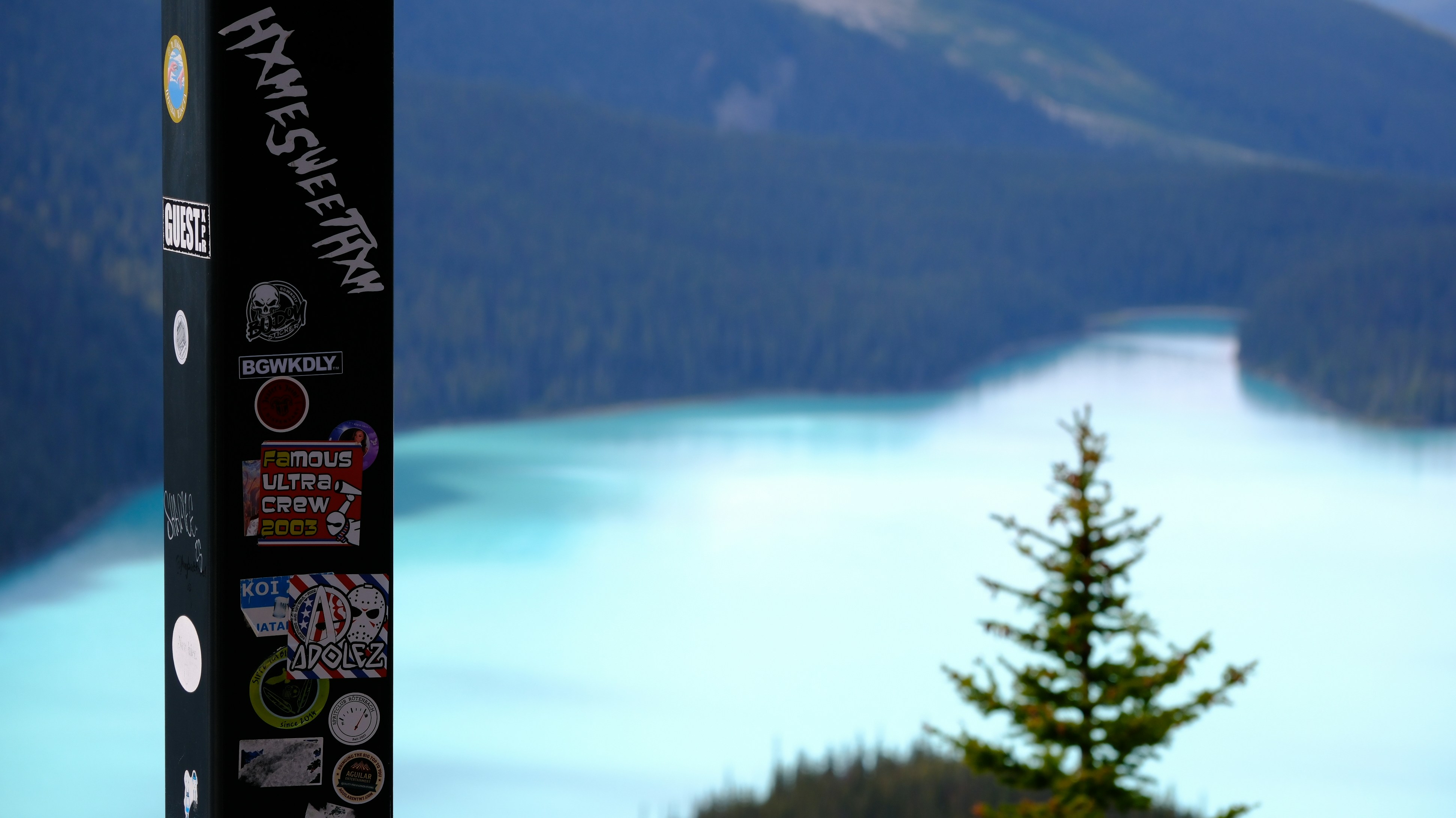 Blue Mist Over a Framed Lake: Stickered Pillar in the Foreground
