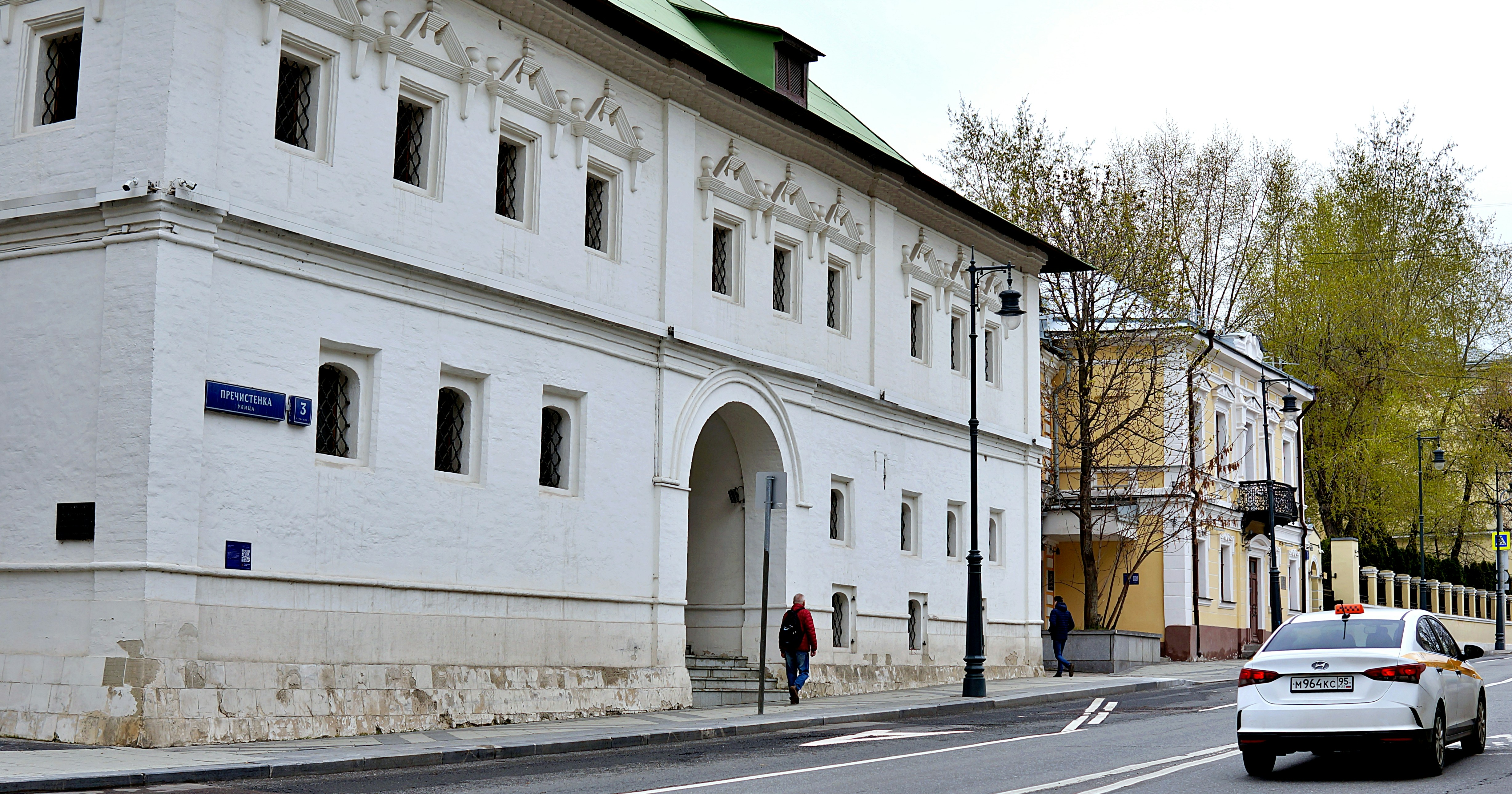 White-walled fortress: archway gateway along a quiet city street