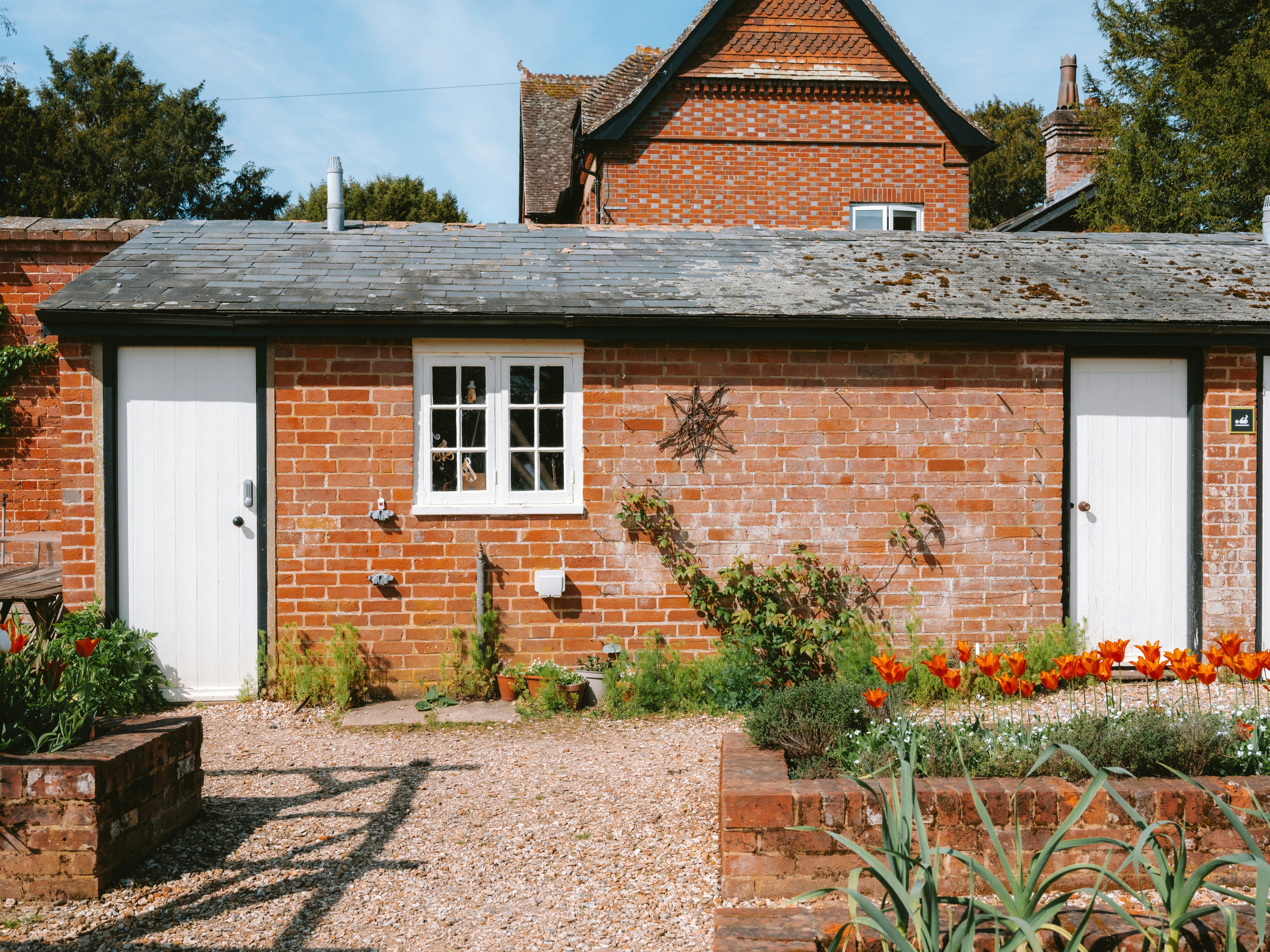 Garden-front Cottage: Brickwork, Flowers and White-door Sequence