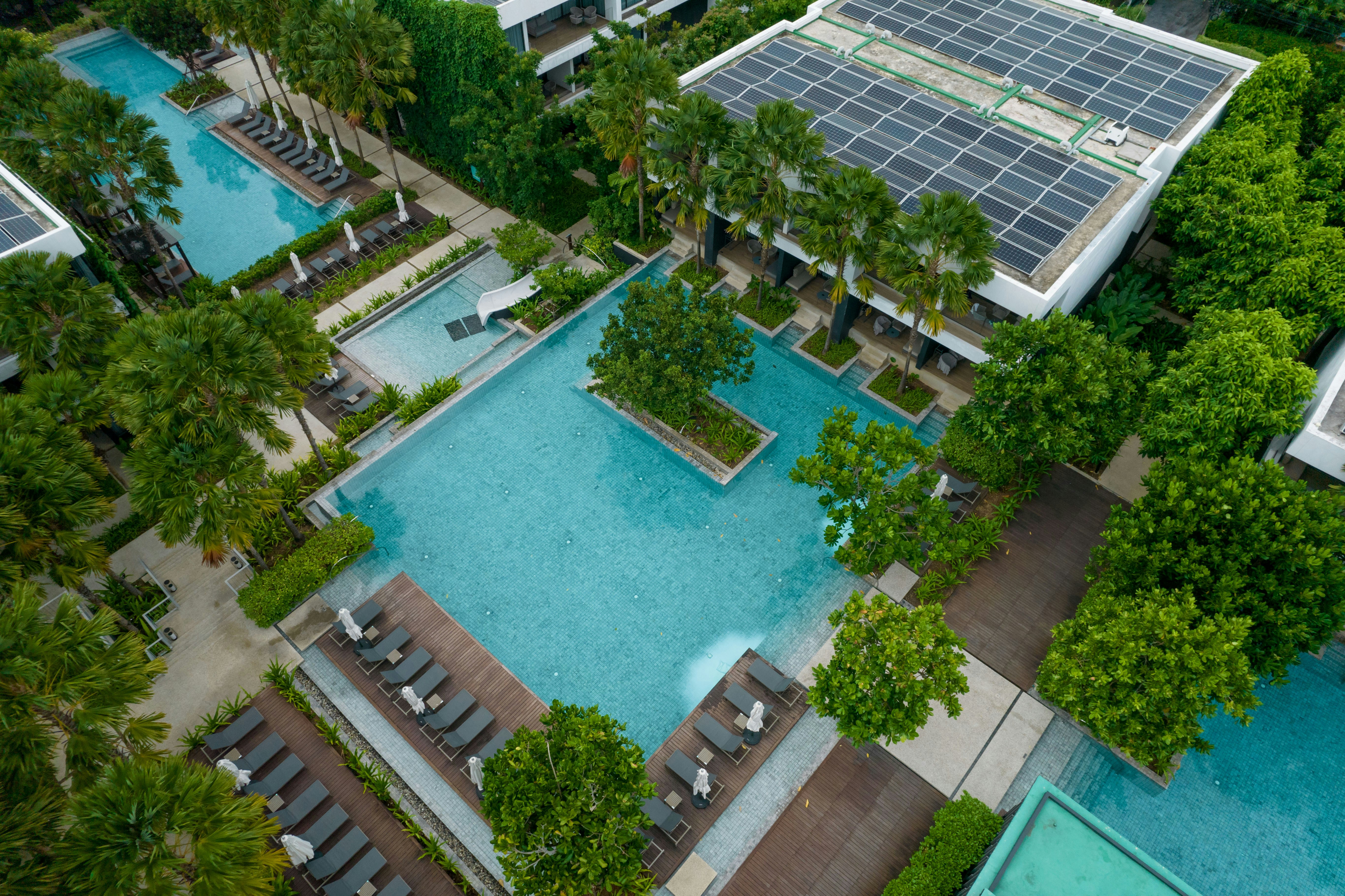 Aerial Oasis: Rectilinear Pools Framing Sunset-Shadowed Lounges