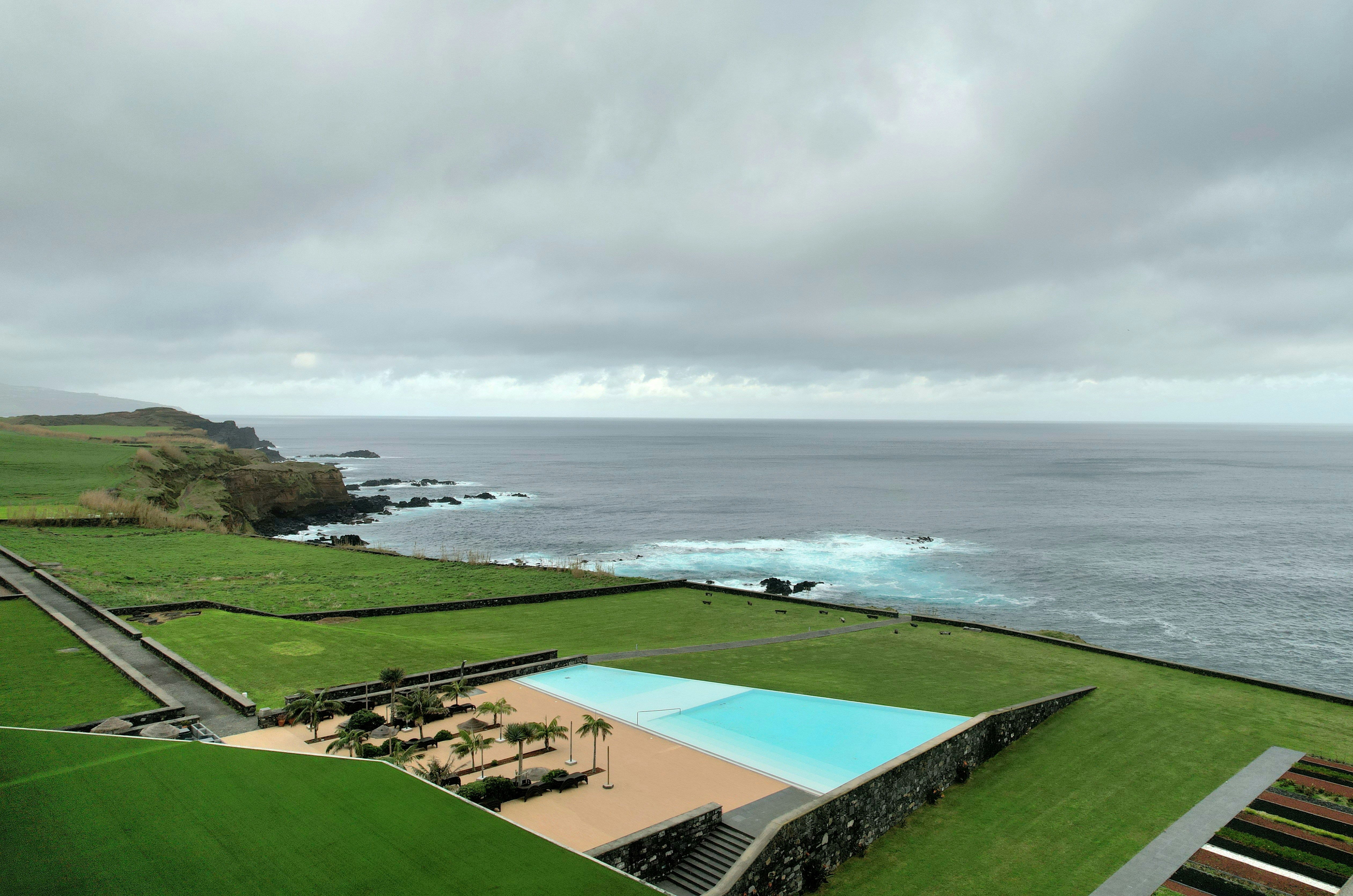 Terraced oceanfront retreat under moody skies