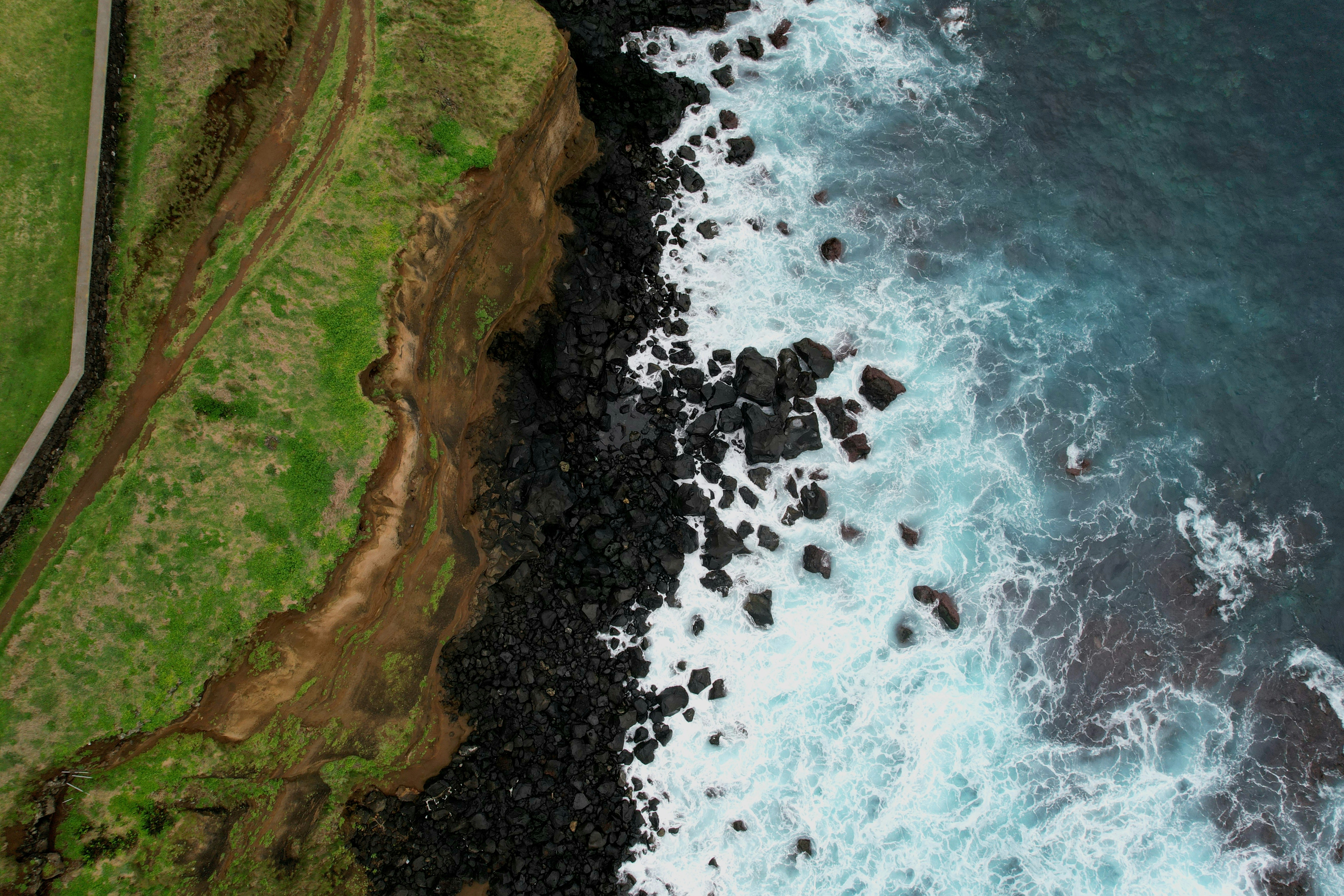 Cliff-edge Vista: Green Slopes Meeting Turquoise Atlantic Foam
