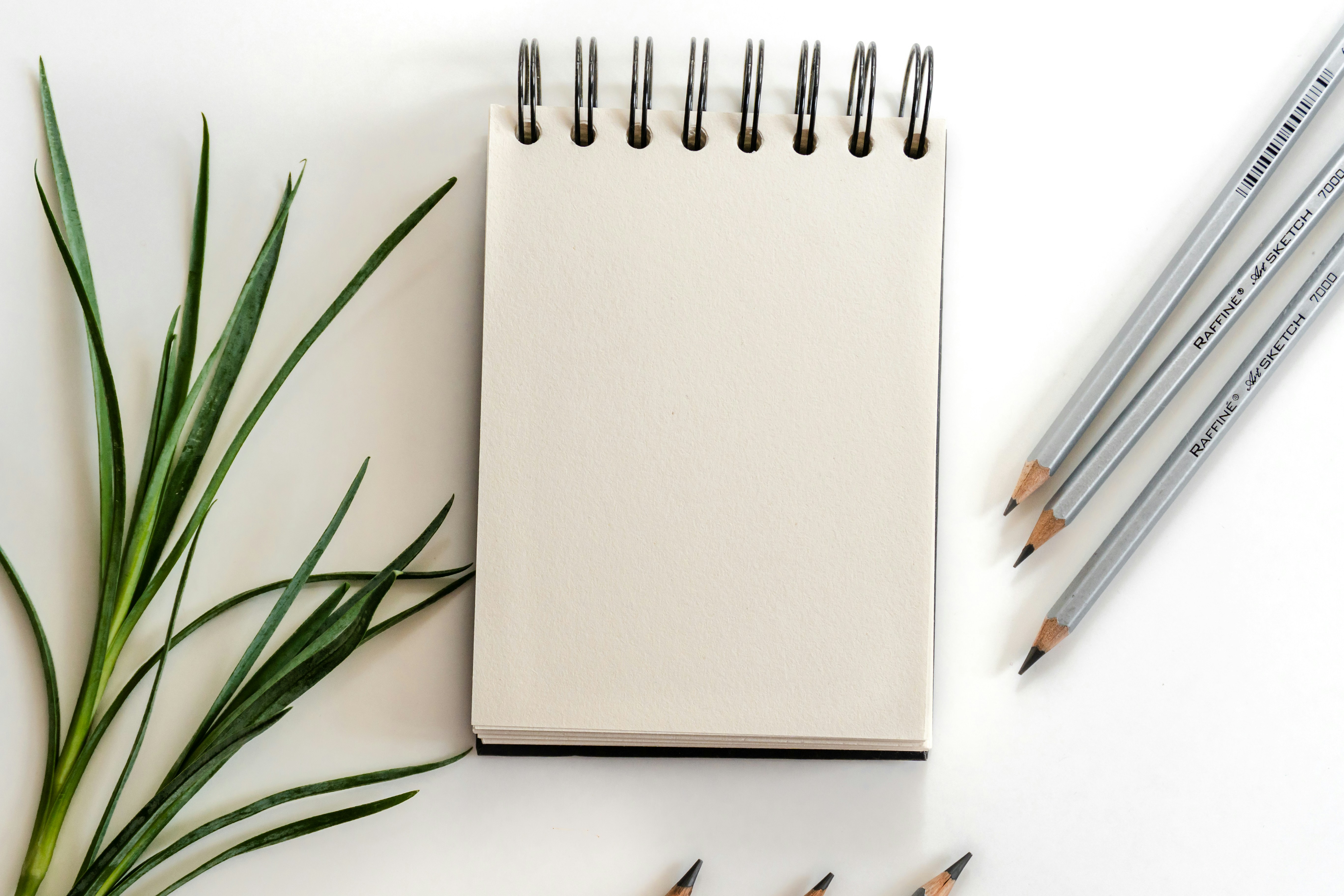 Minimal Studio: A Spiral-Bound Notebook Centered Amid Sketching Pencils