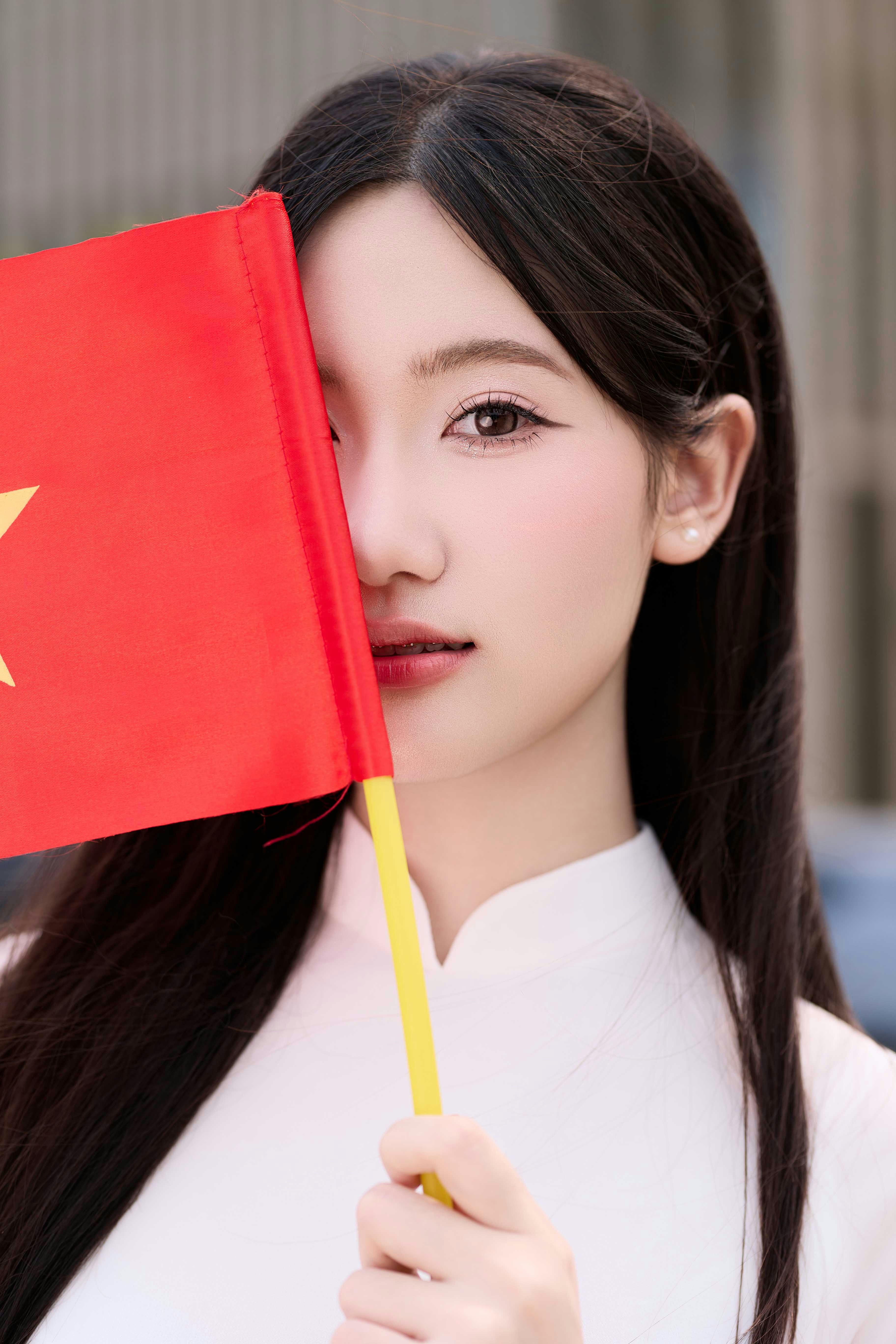 Half-Cover Portrait: A Quiet Gaze Behind a Red Flag