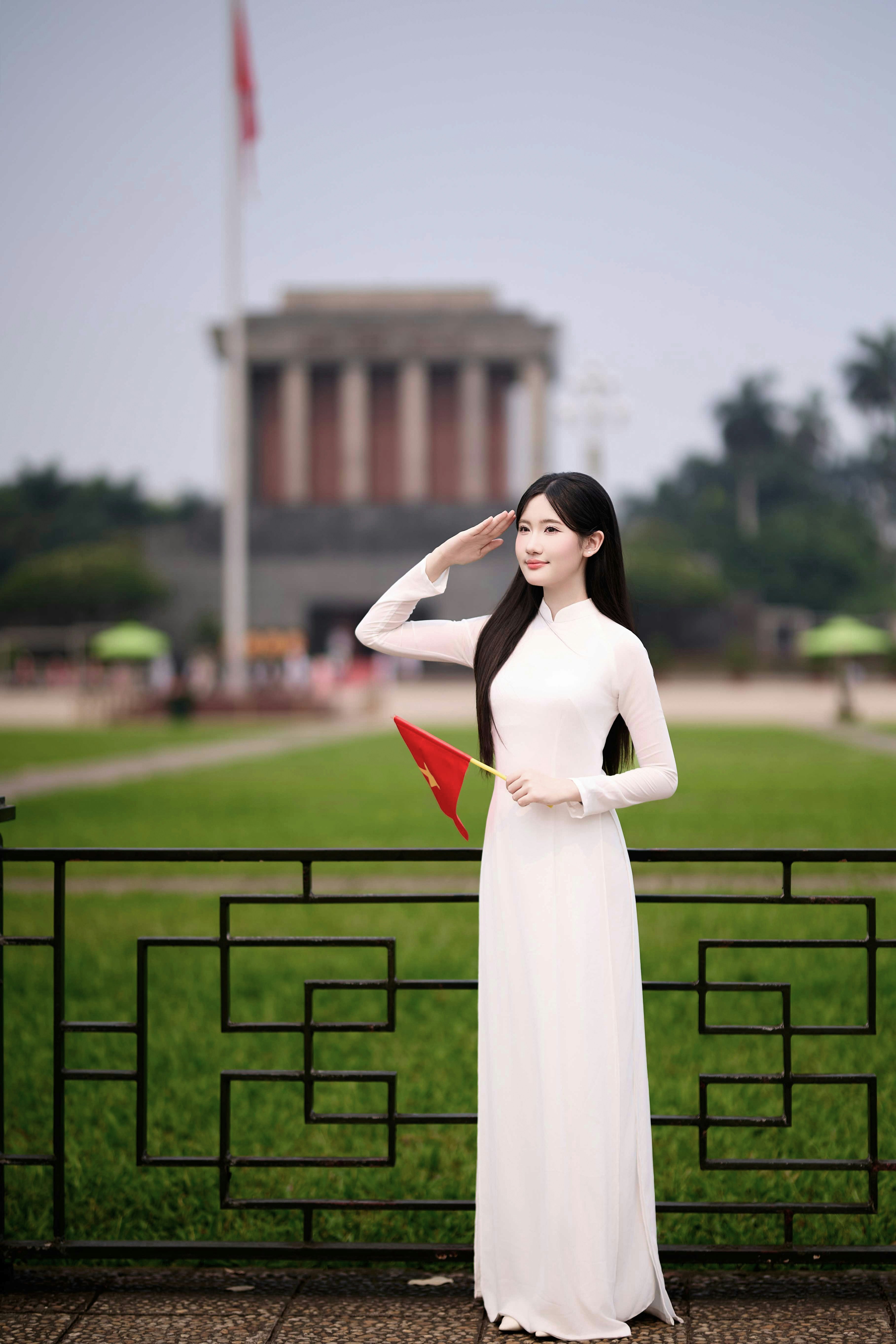 White Dress, Red Flag: Portrait at a Vietnamese Memorial Grounds