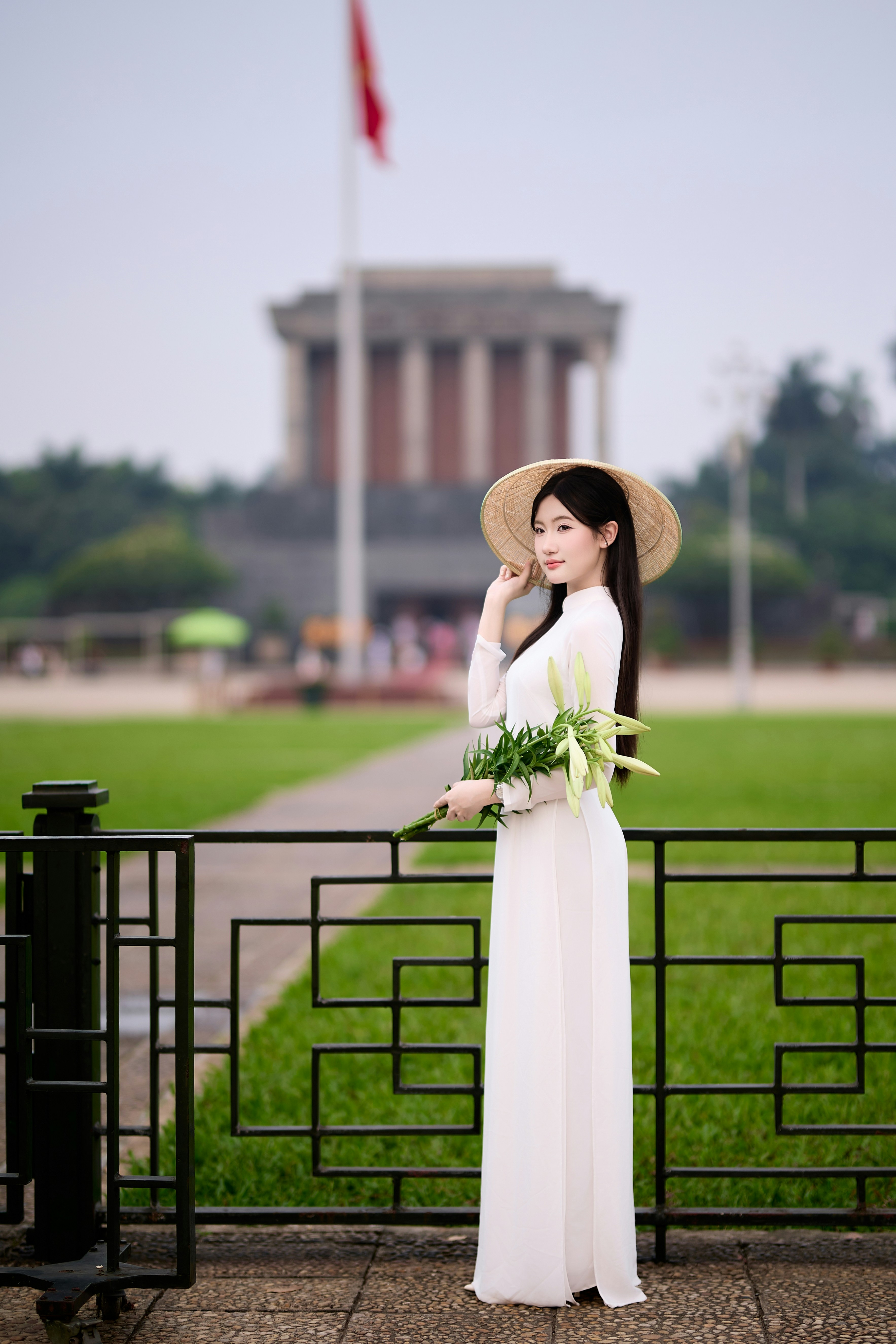 Portrait in a Field of History: The White Dress and Straw Hat by the Gate