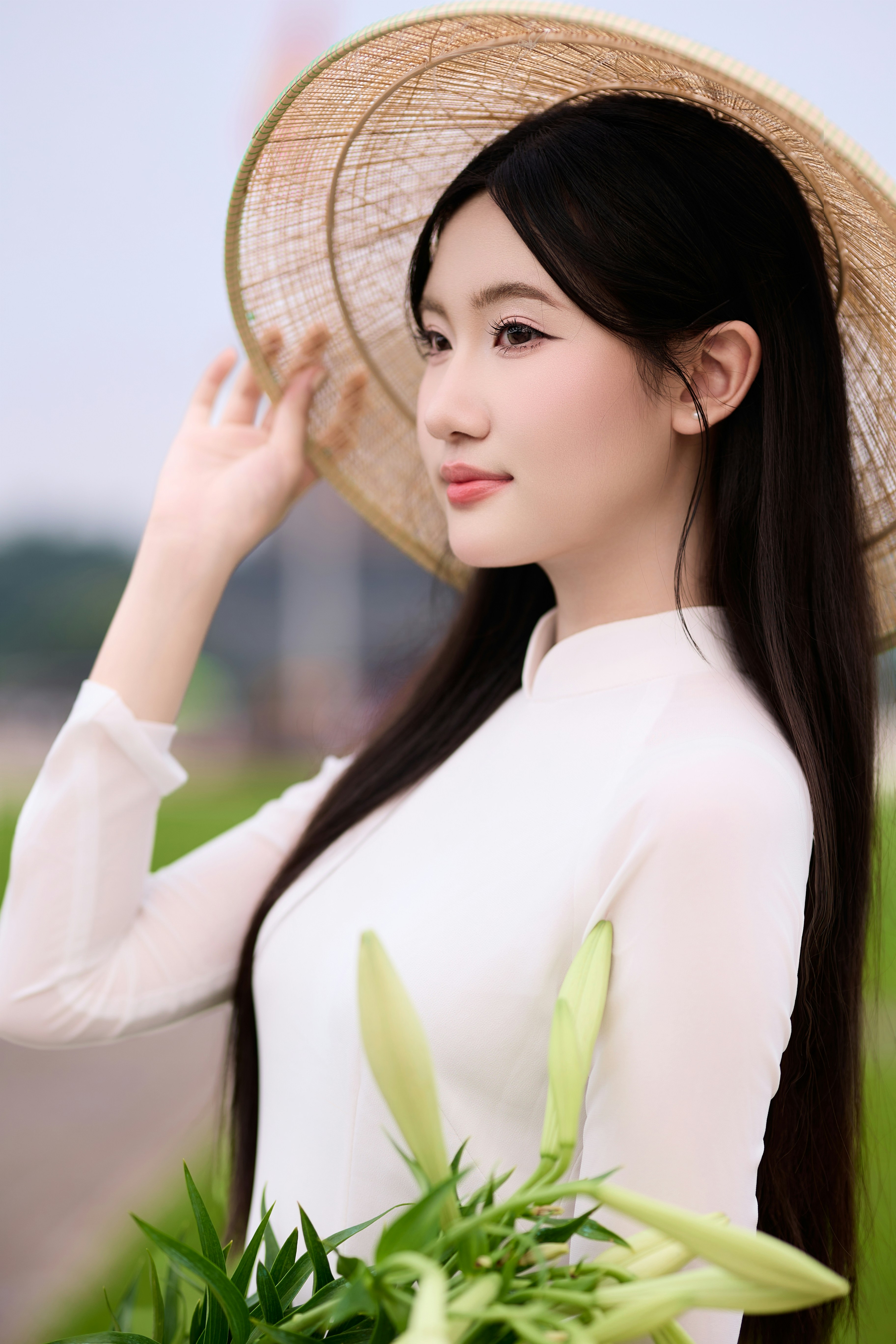 Portrait in Straw: A Quiet Moment with a Sunlit Hat