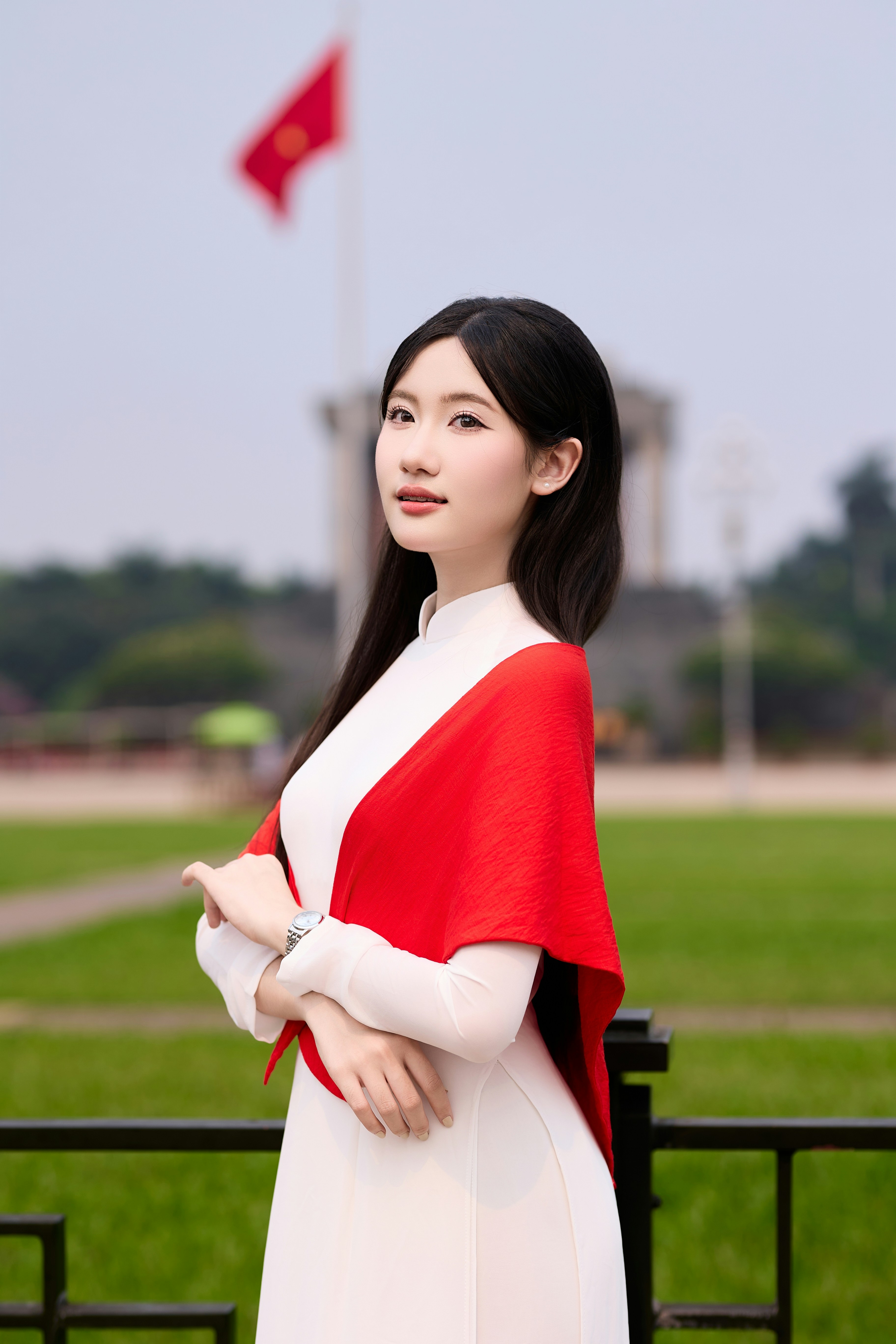 Portrait in Red: Graceful Poise Under a National Flag