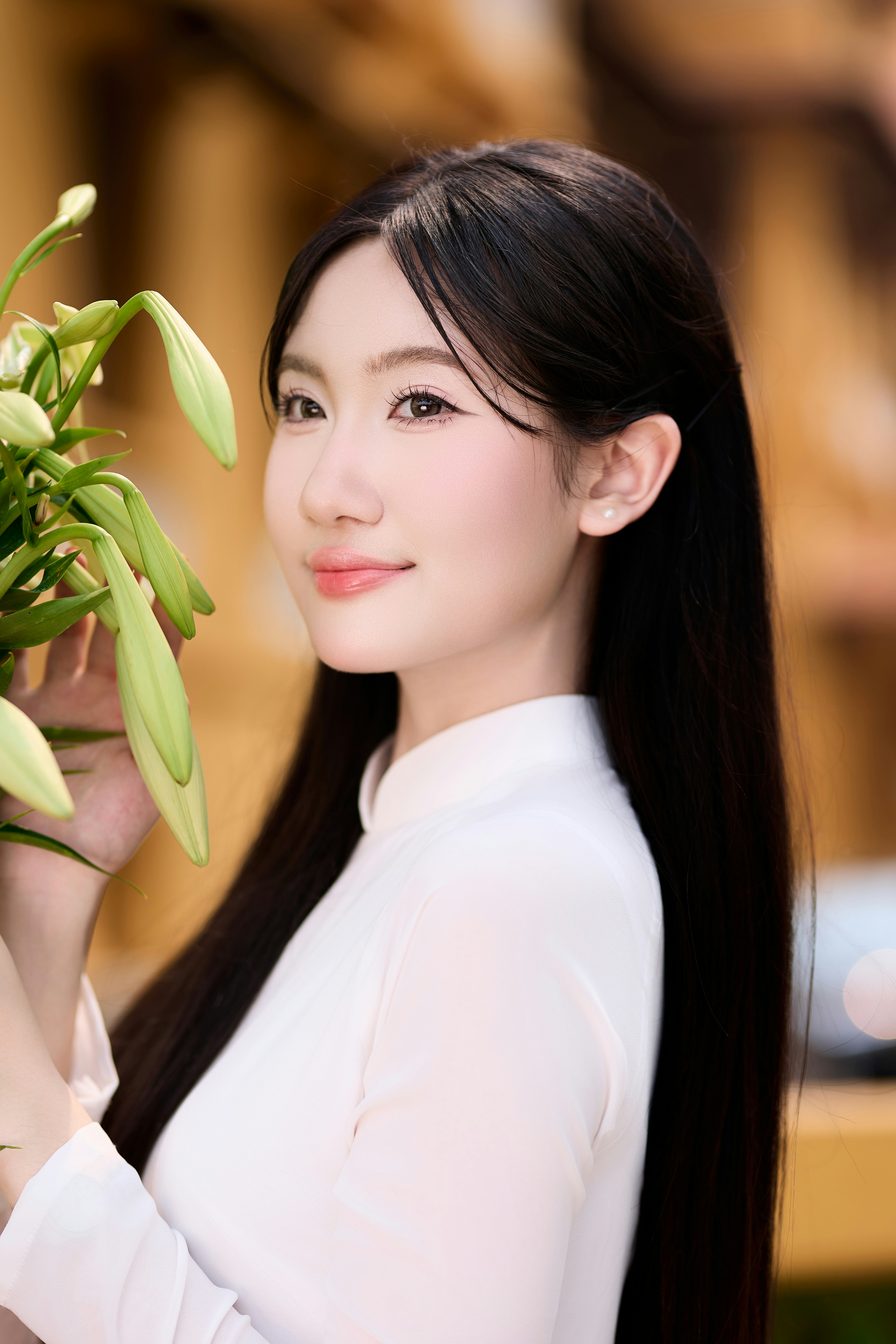 Soft Portrait with a Gentle Smile and Green Fronds