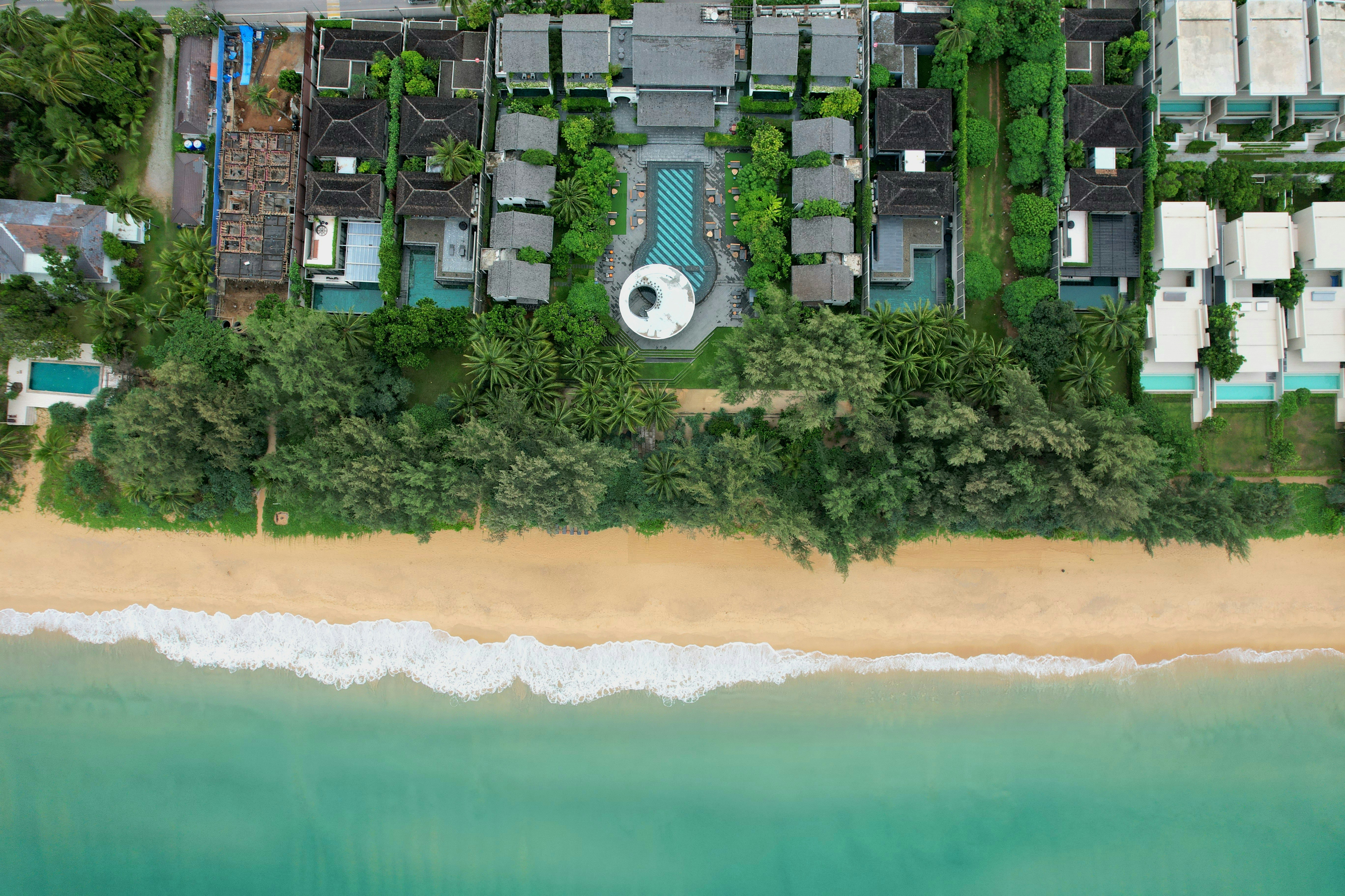 Coastal Retreat: Aerial Ribbon of Beach and Villas Fringing Lagoon